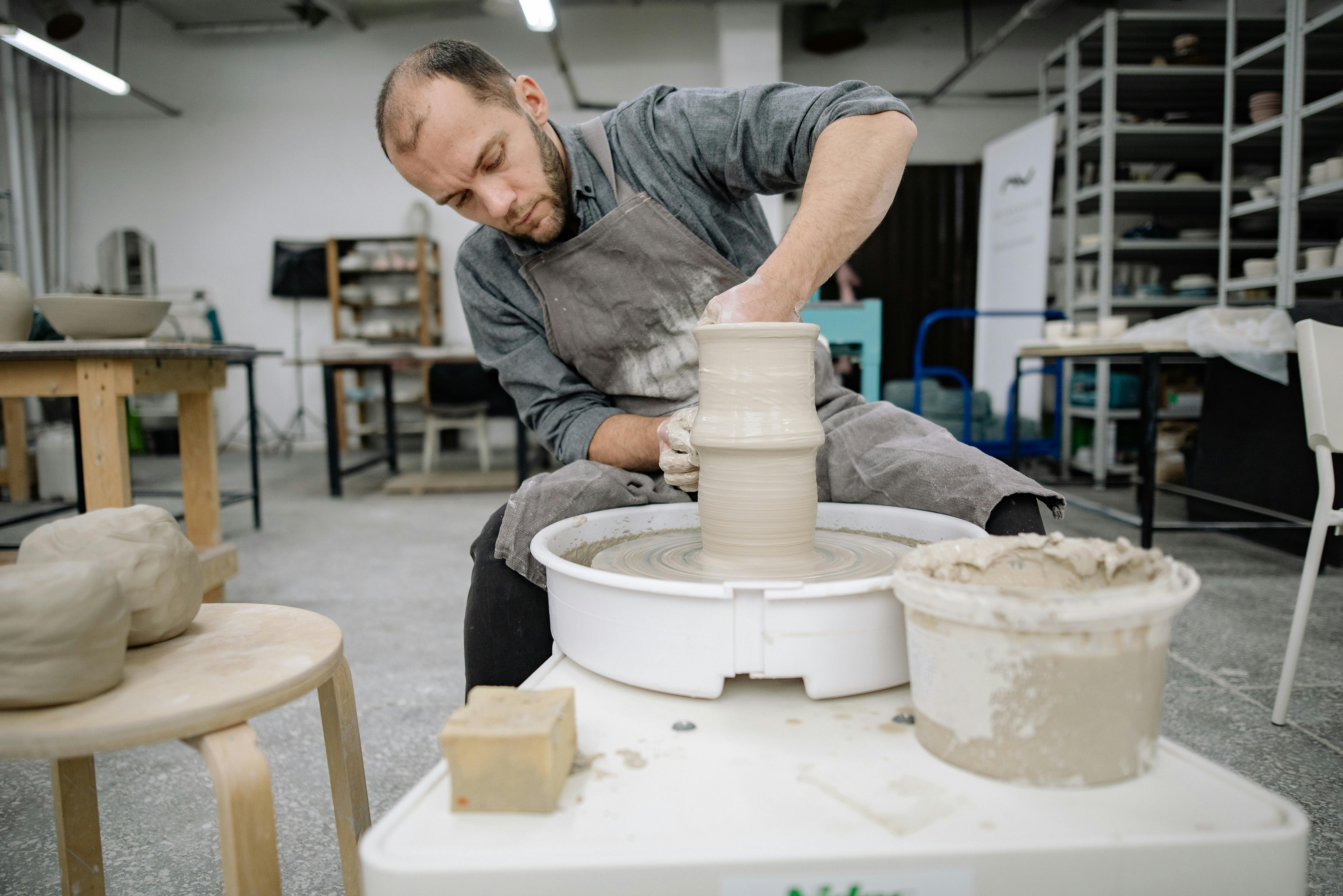 Hands of a Potter Making a Vase with a Pottery Wheel · Free Stock Photo