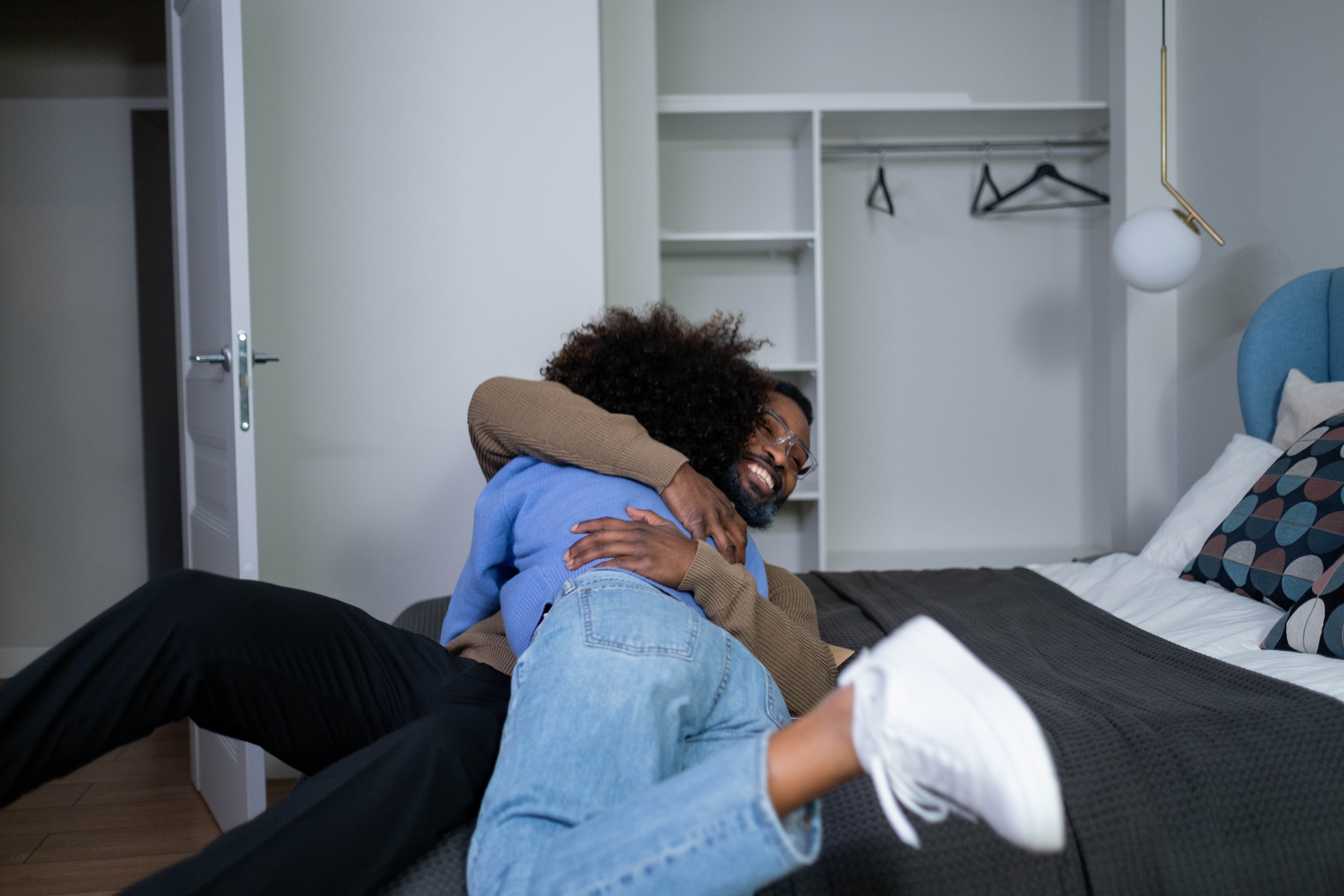 A Person and a Man Hugging on the Bed · Free Stock Photo