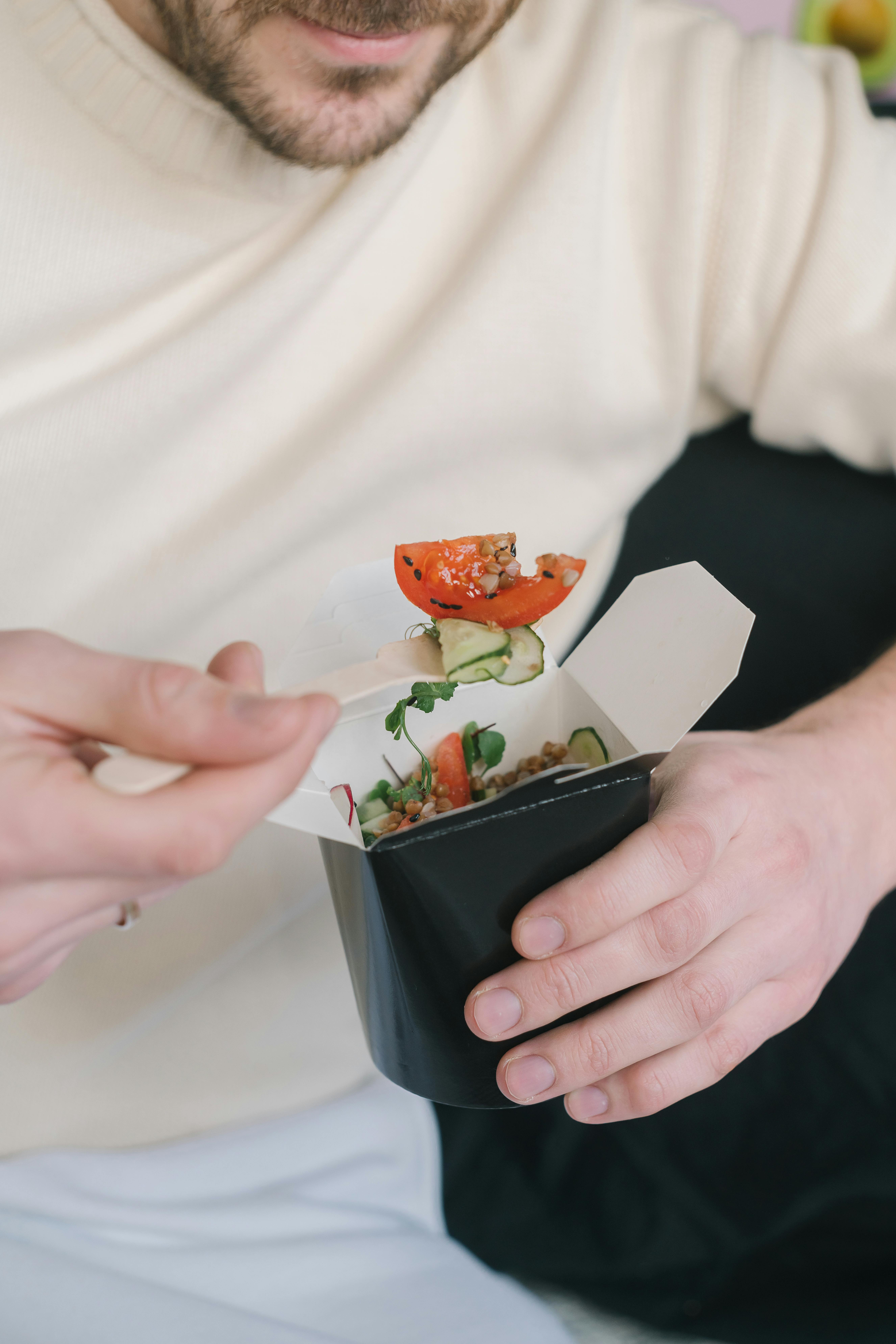 A Mean Eating Healthy Food from a Takeout Box · Free Stock Photo