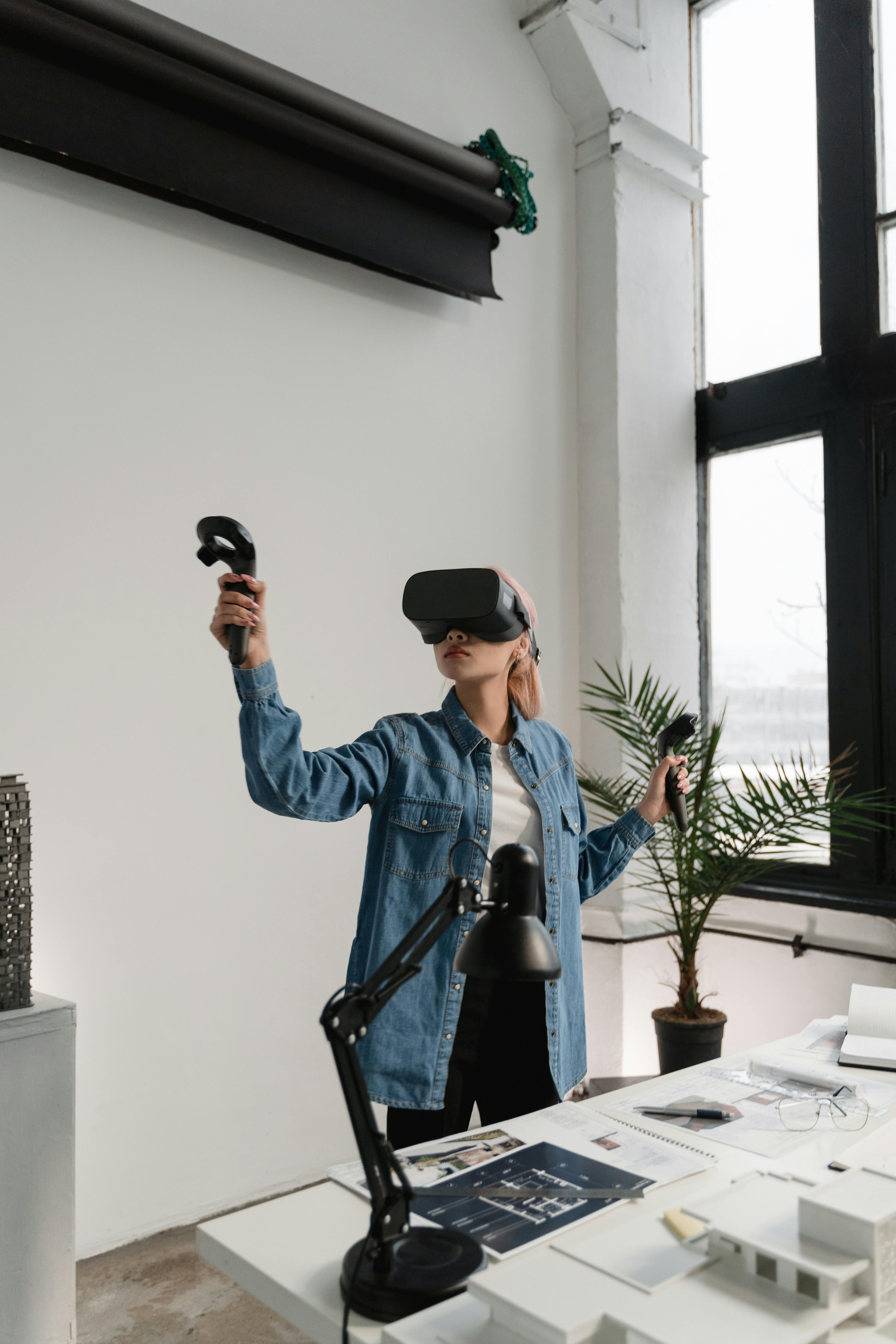 A Woman Standing Near a Desk Playing with a VR · Free Stock Photo