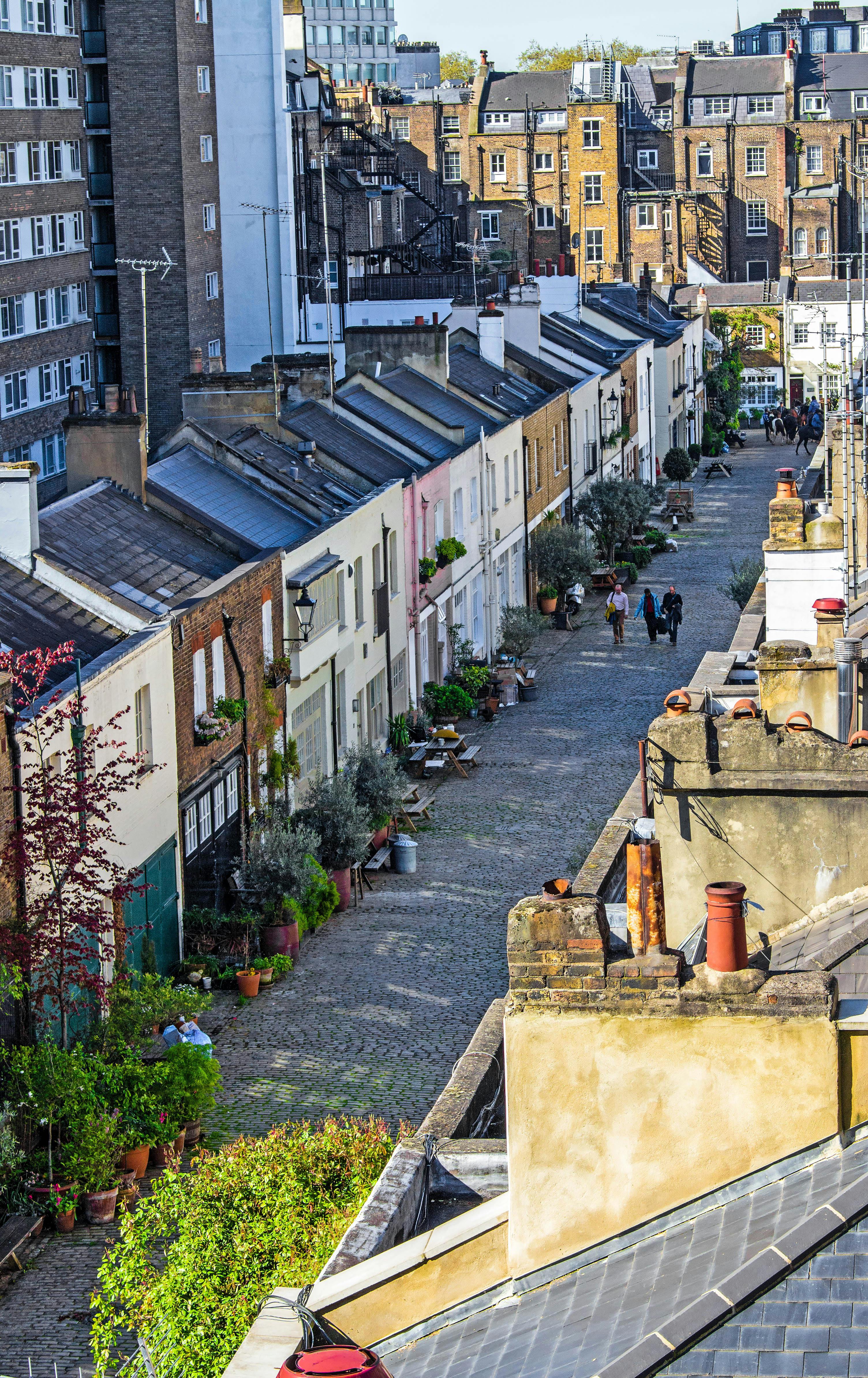 Concrete Houses Along a Cobblestone Street · Free Stock Photo