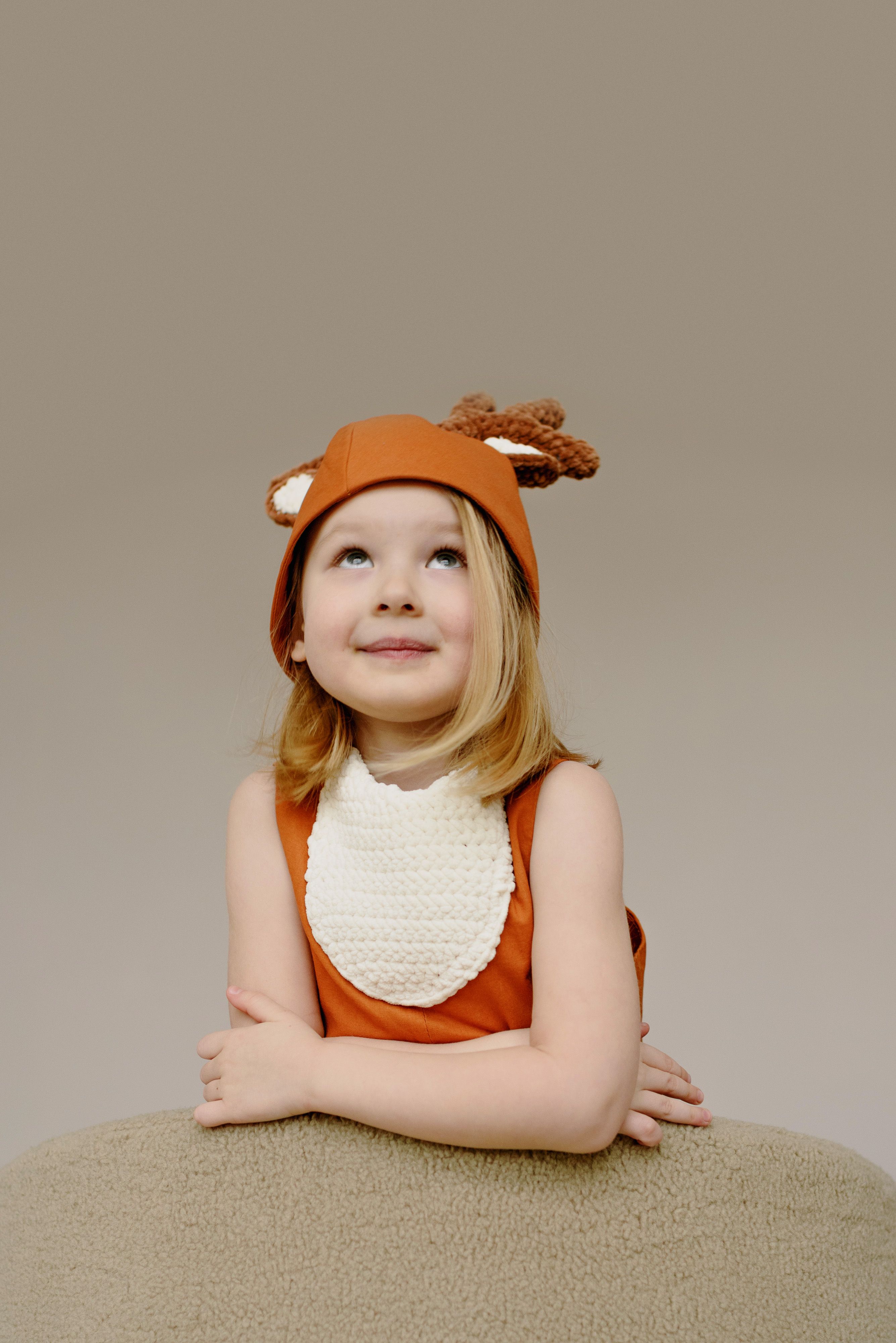 A Child in Red Hoodie Standing Beside Brown Deer · Free Stock Photo