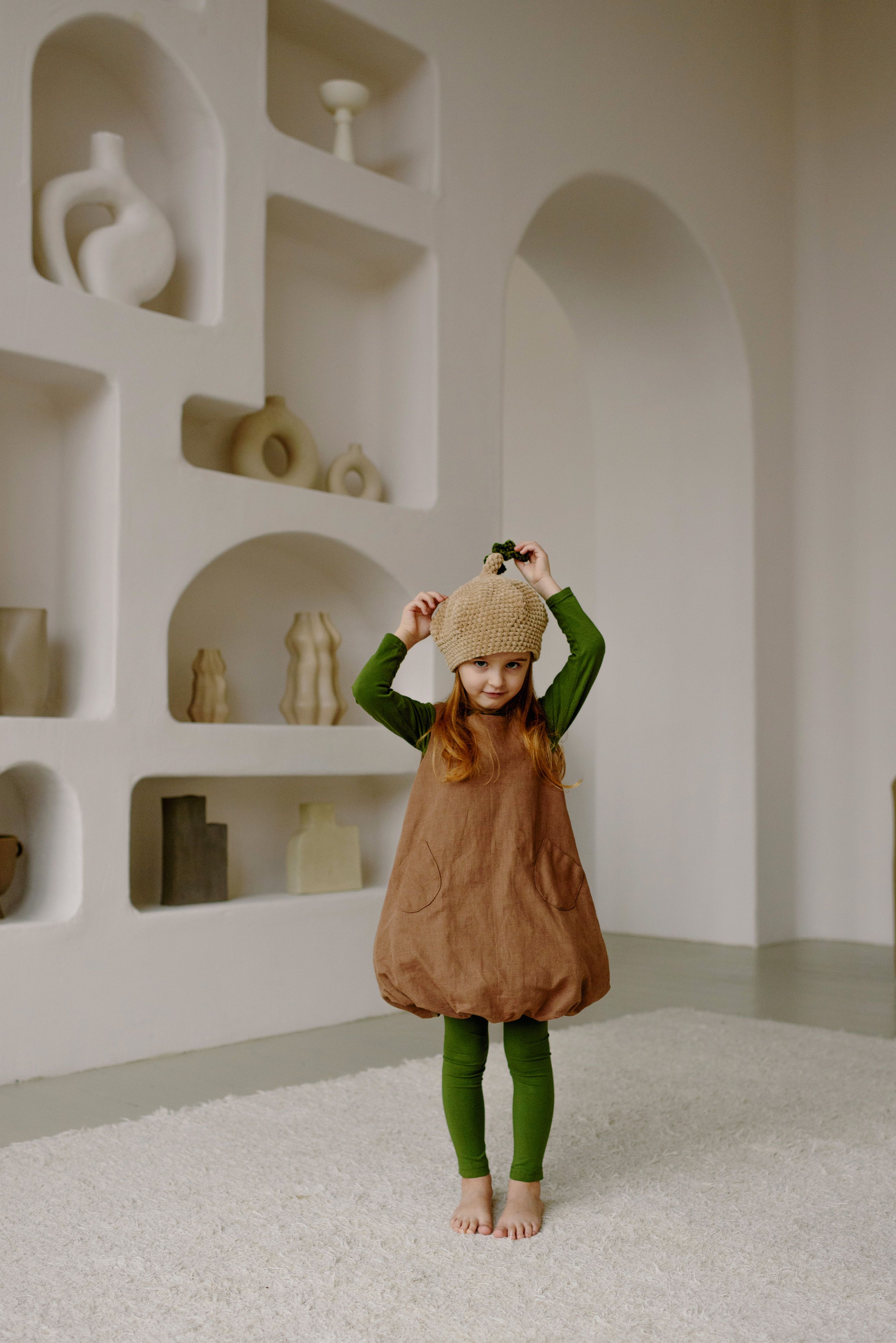 A Girl Sitting on Customized Shelf · Free Stock Photo