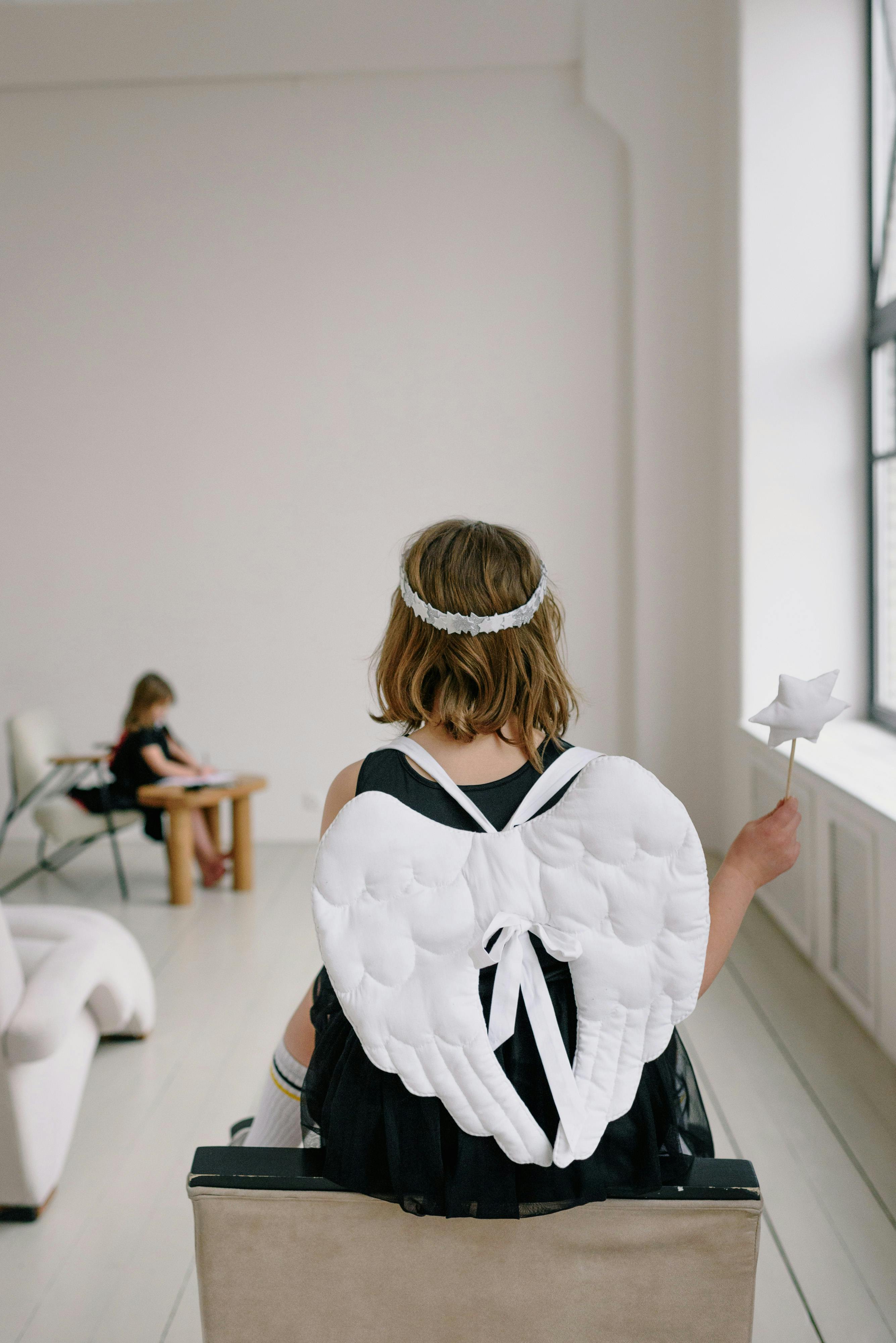 A Girl in Black Angel Costume Sitting · Free Stock Photo