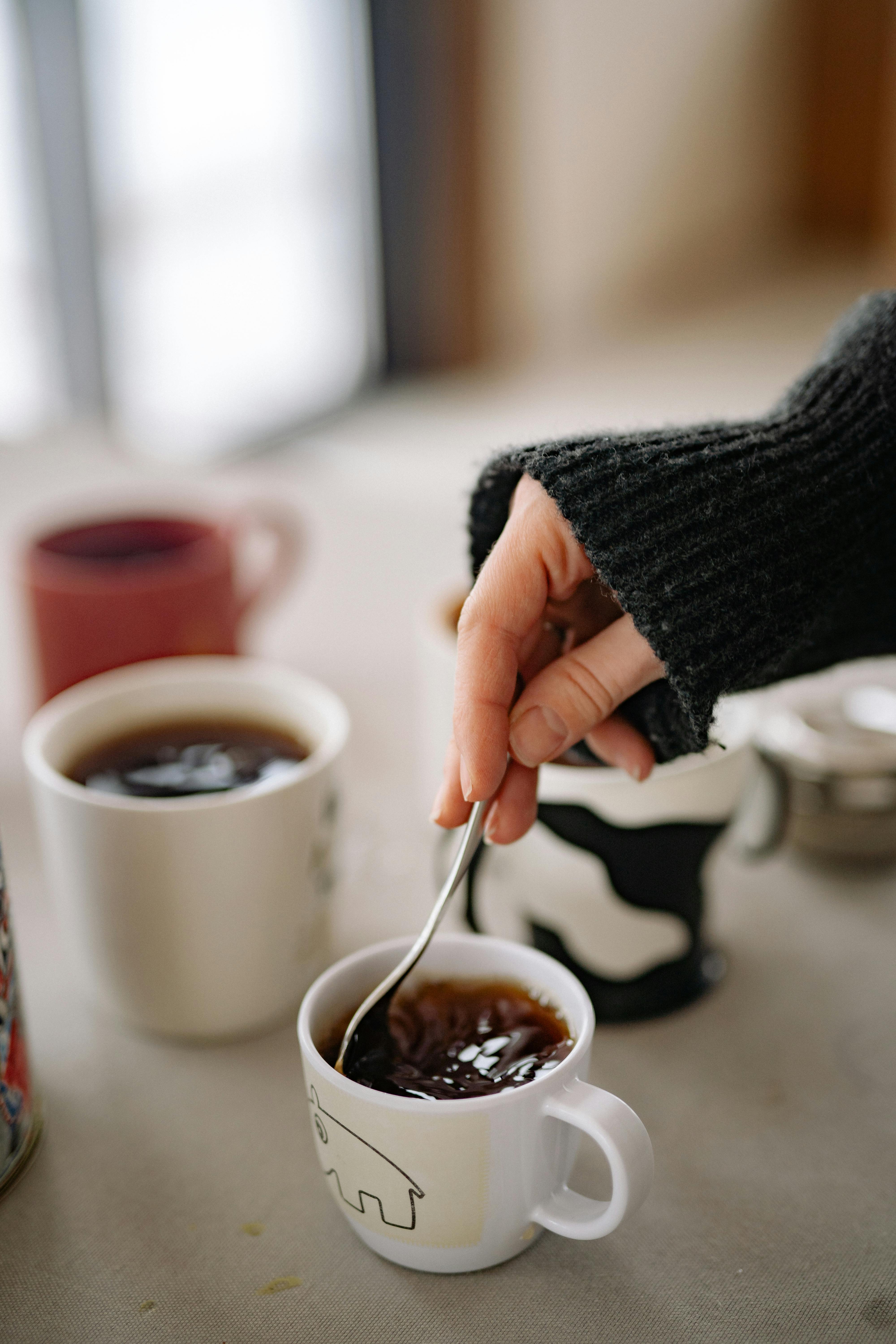 Person Holding Silver Spoon · Free Stock Photo