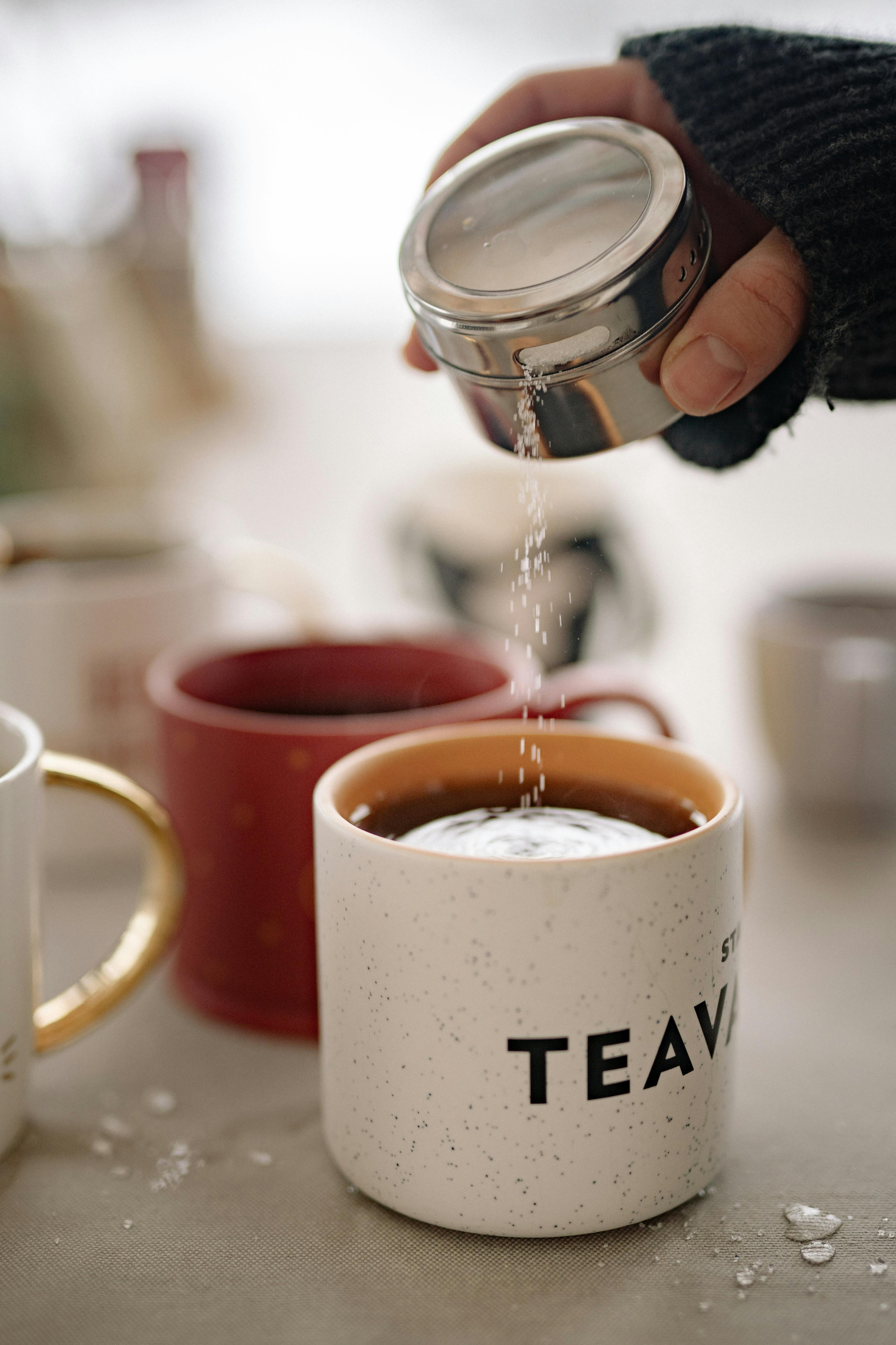 Person Adding Sugar to the Tea · Free Stock Photo