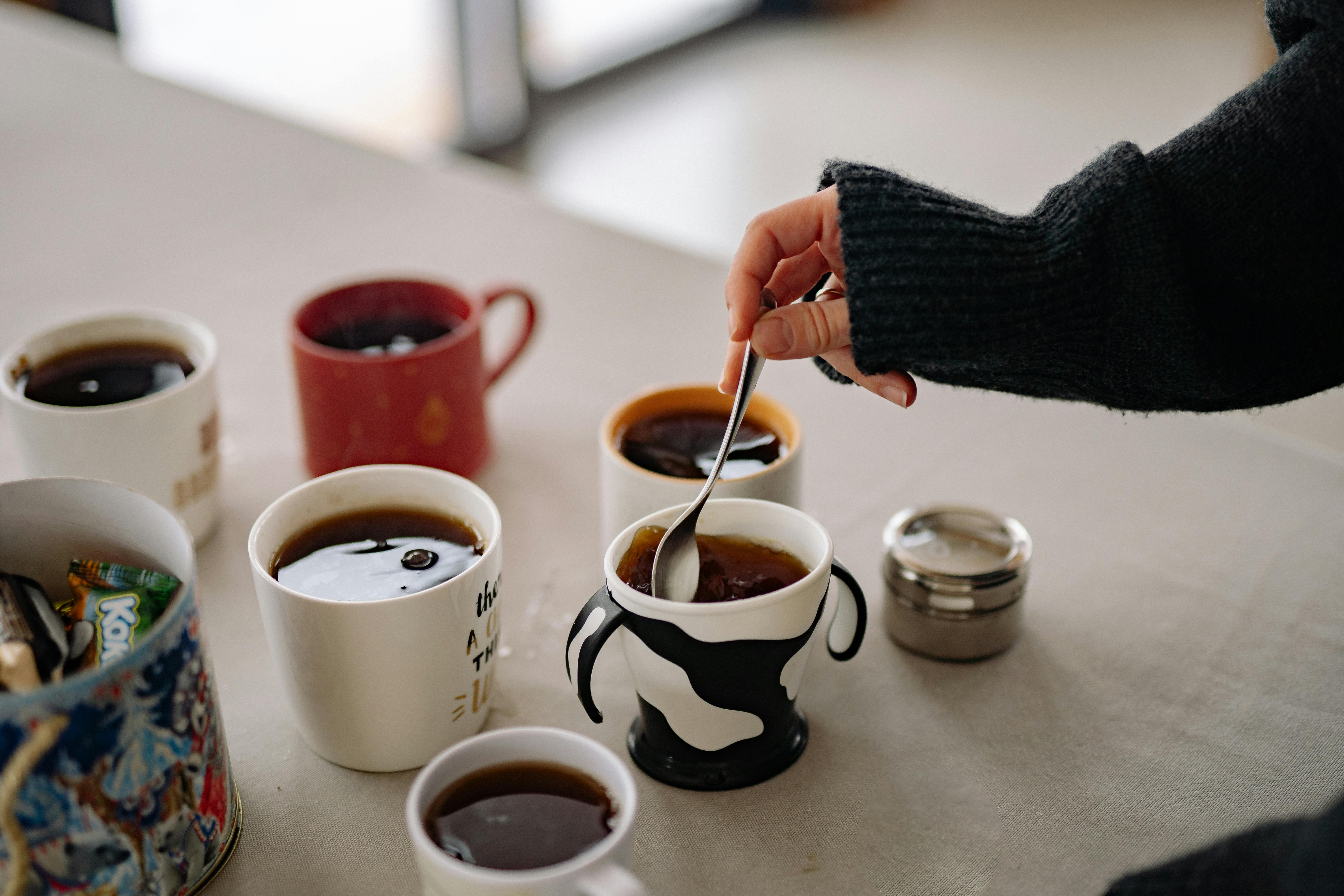 Woman Stirring Tea in a Cup · Free Stock Photo