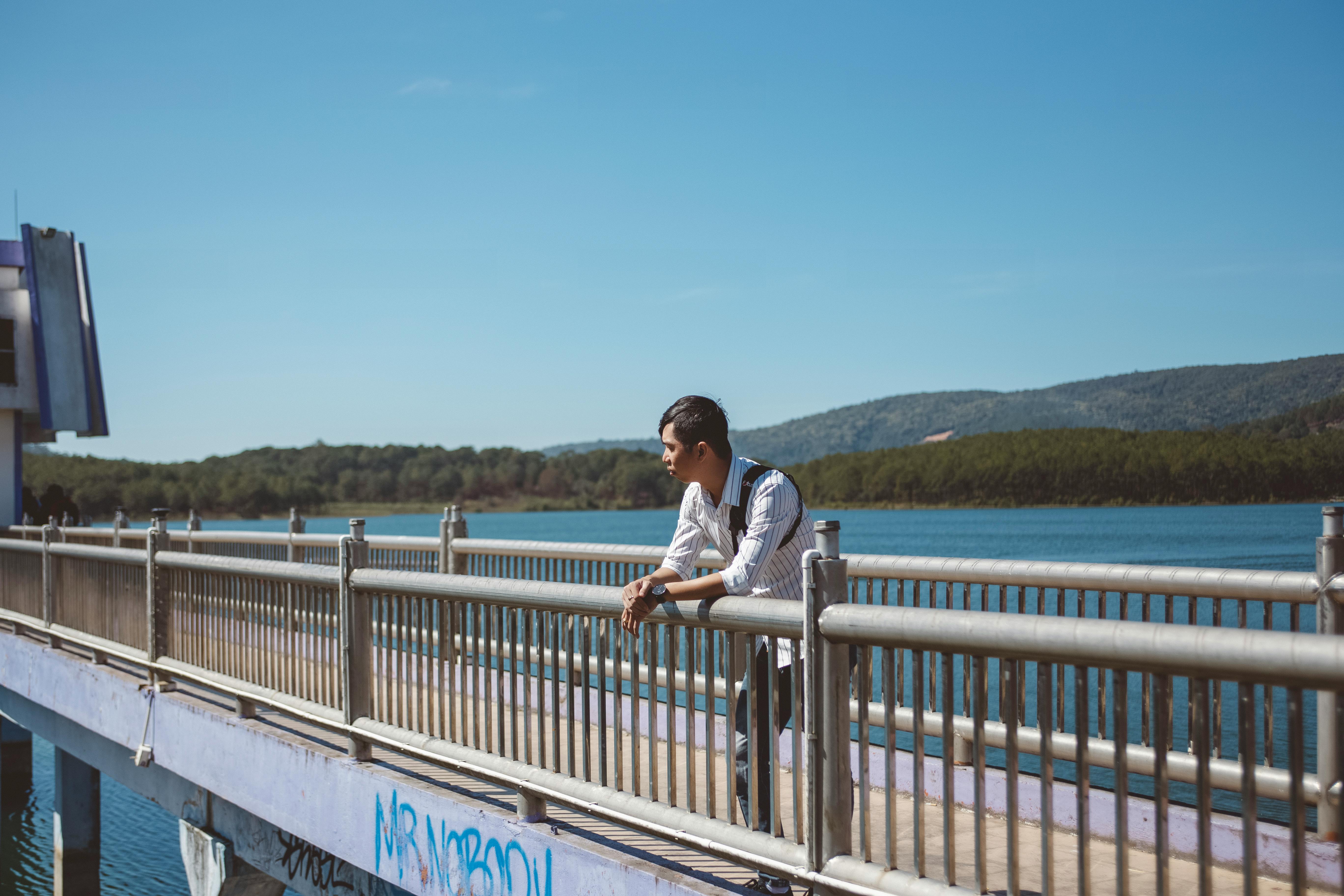 Man Standing on Bridge over Lake · Free Stock Photo