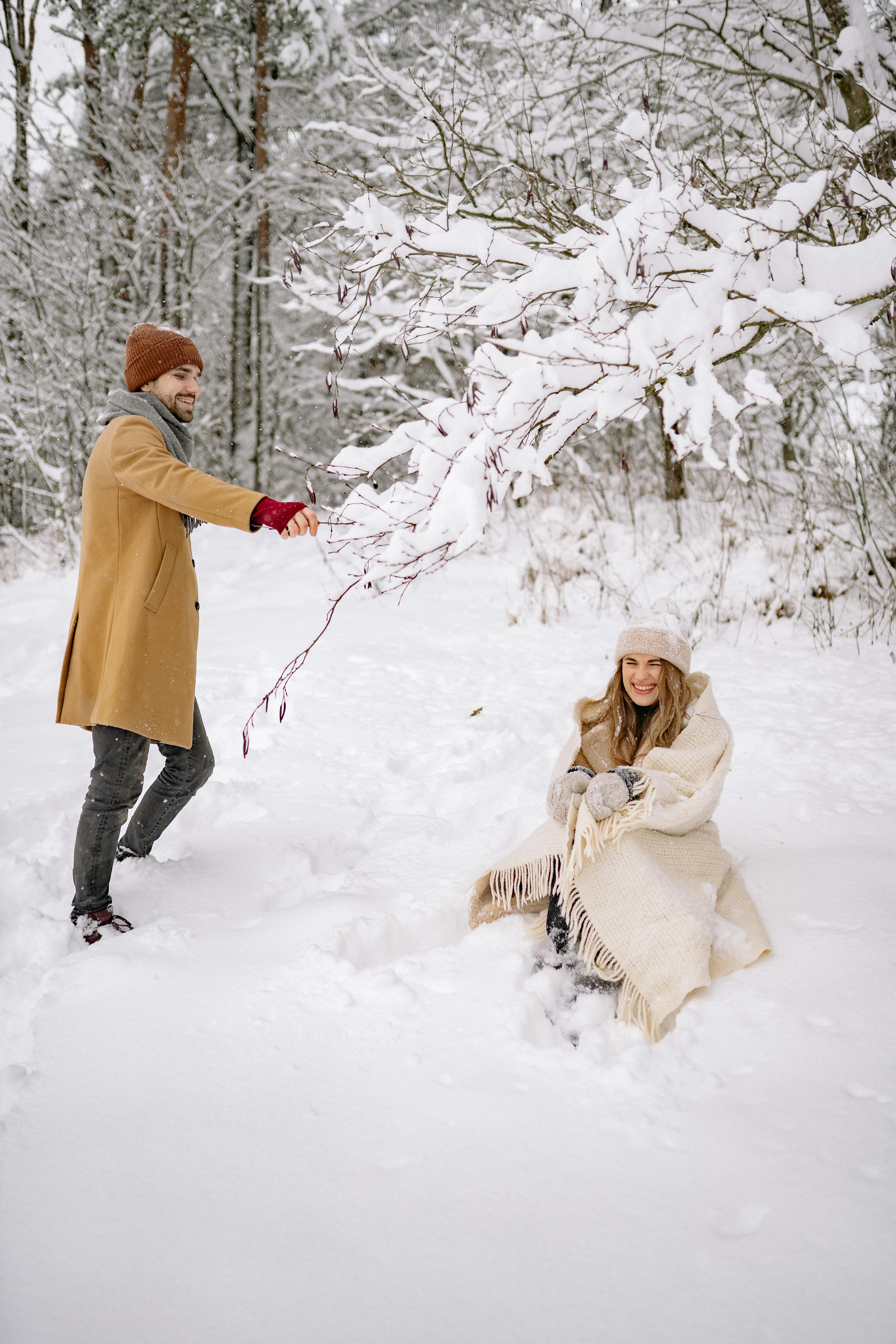 A Happy Couple Having Fun Playing in the Snow · Free Stock Photo