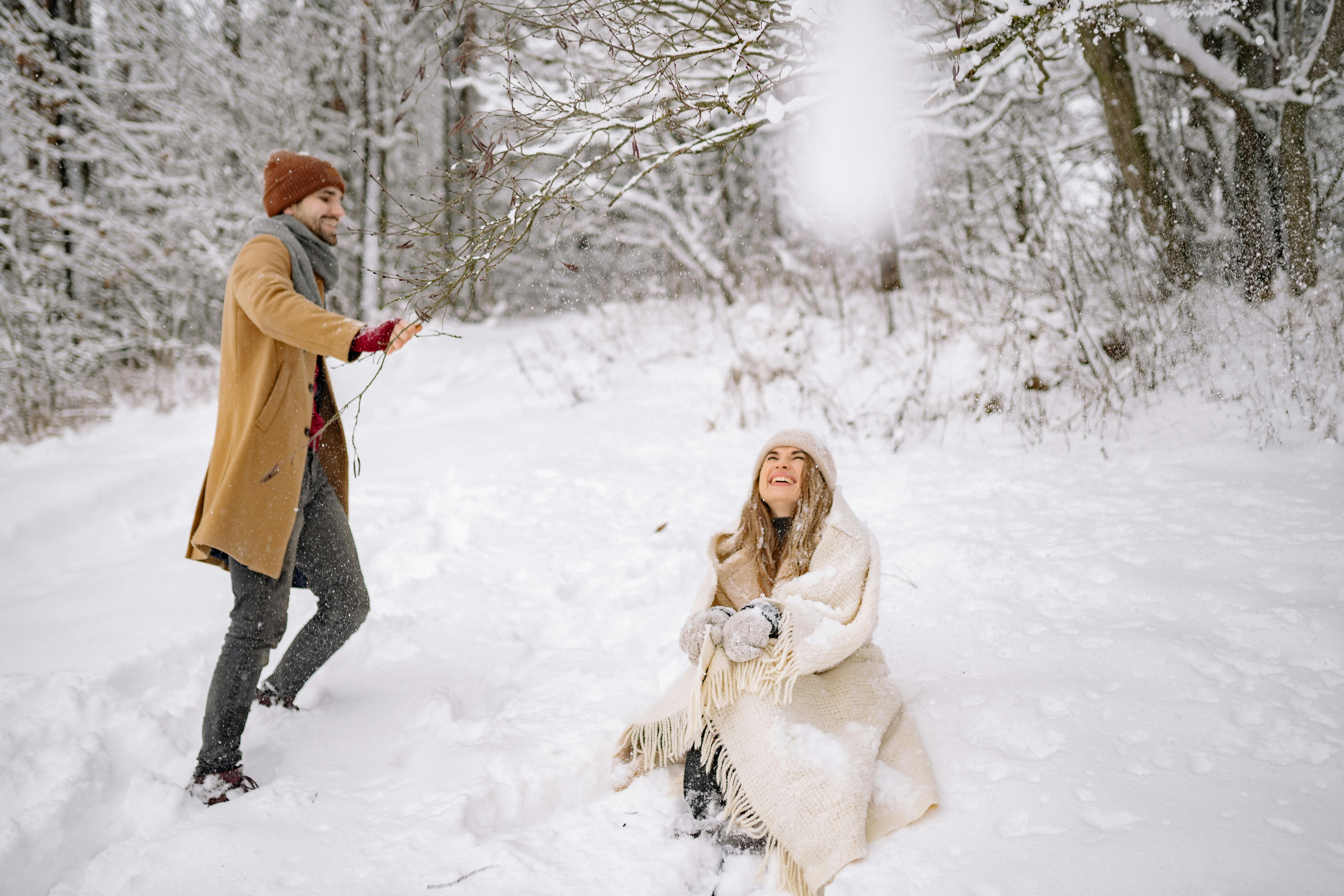 A Happy Couple Having Fun Playing in the Snow · Free Stock Photo