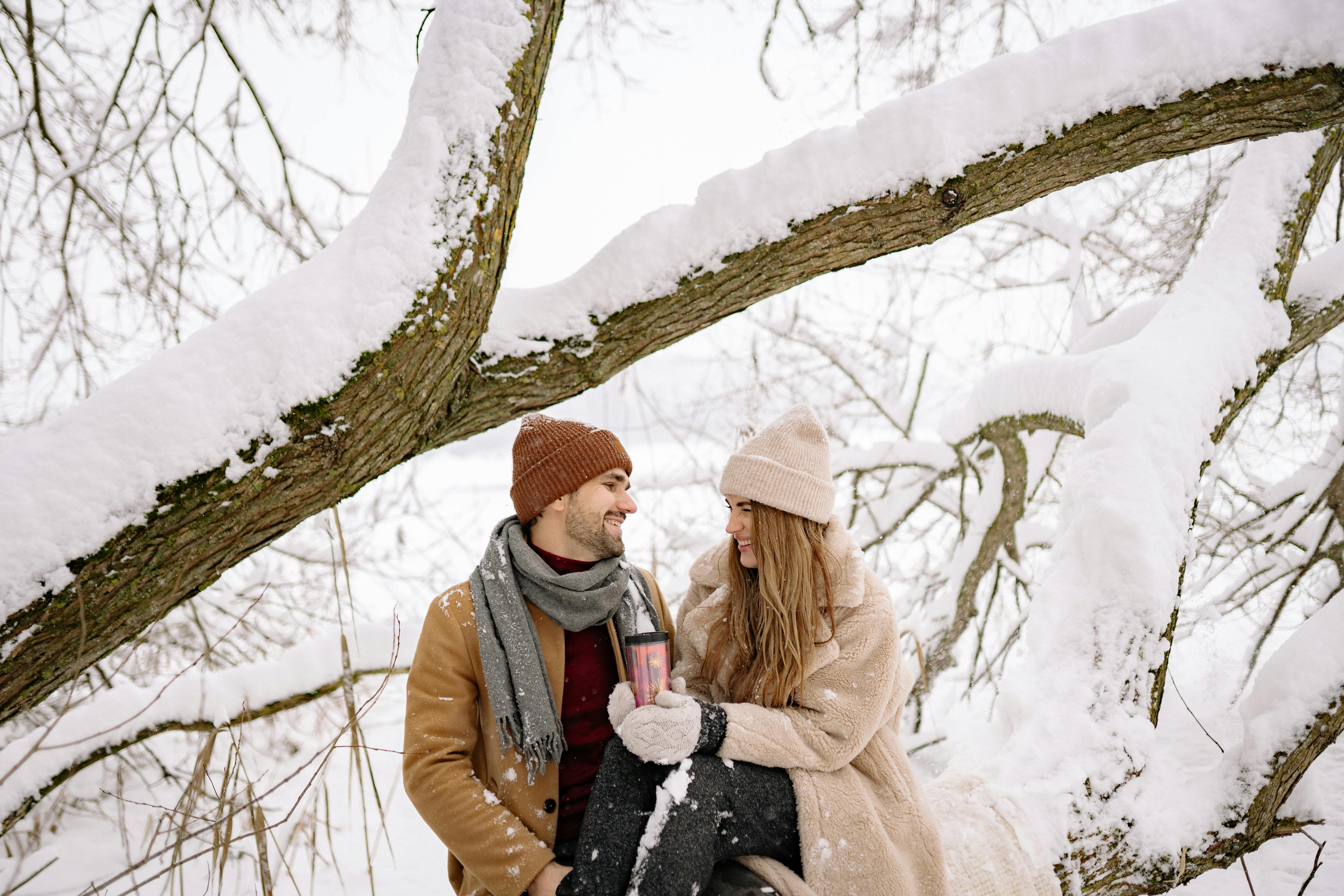 A Happy Couple Having Fun Playing in the Snow · Free Stock Photo