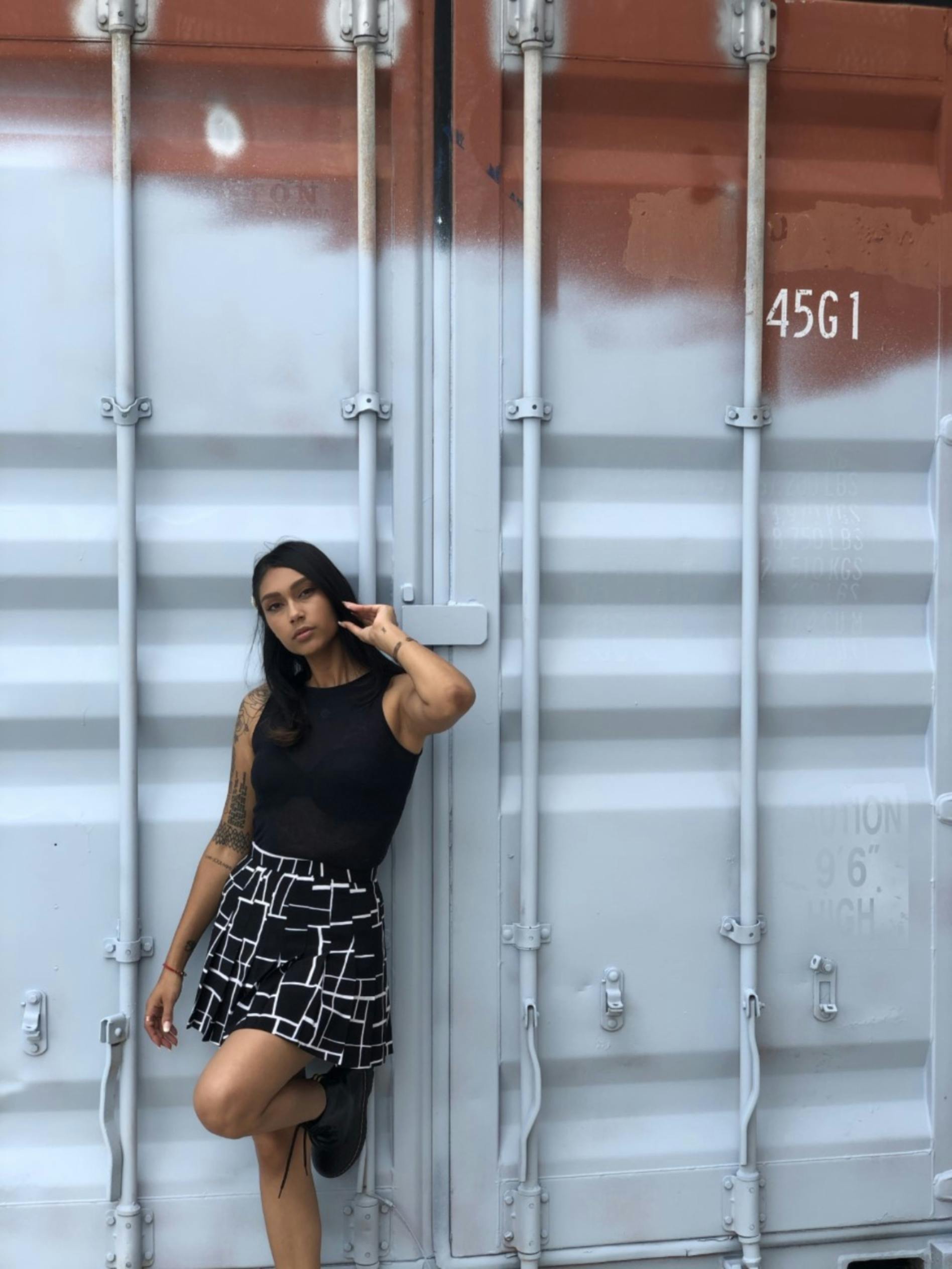 Woman and Man Standing Beside Metal Shipping Container · Free Stock Photo