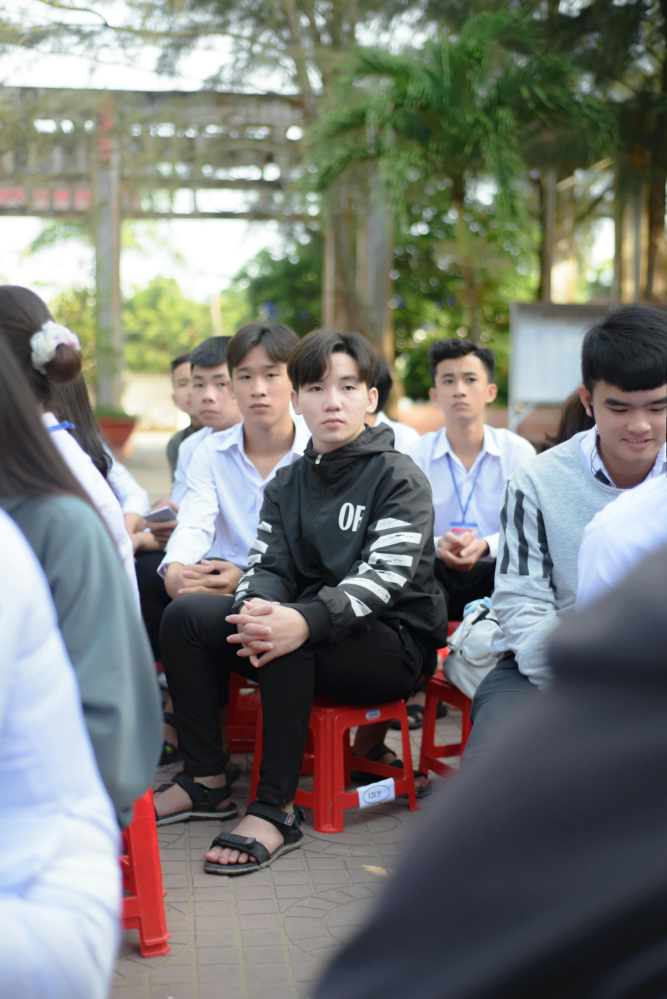 People Sitting on Plastic Chairs · Free Stock Photo