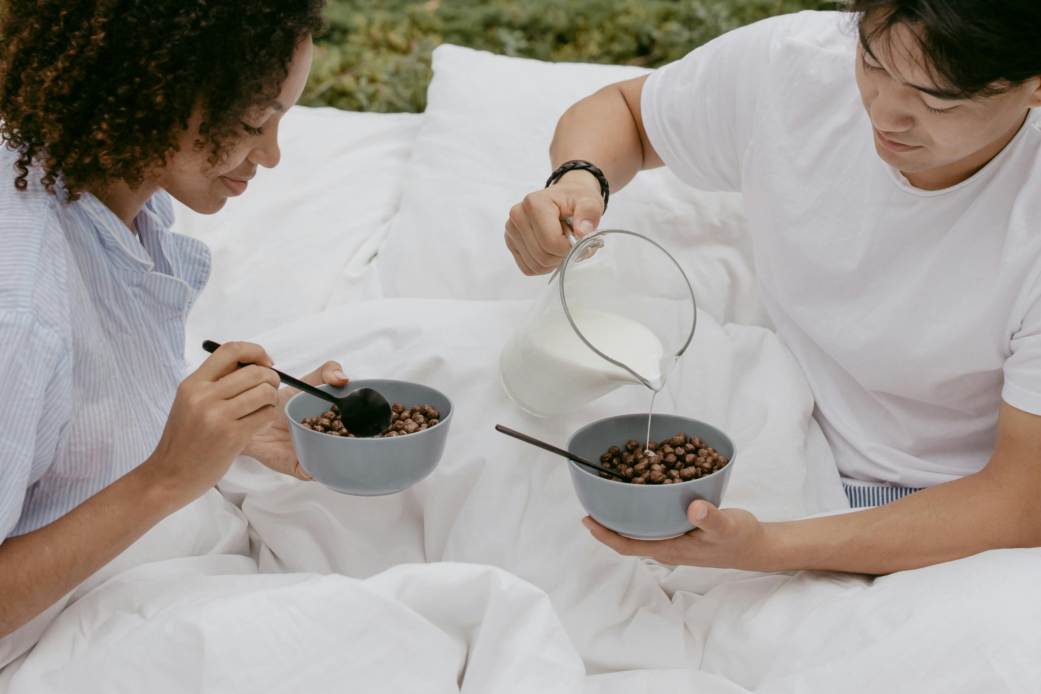 Two Person Eating Pancake on White Wooden Floor · Free Stock Photo