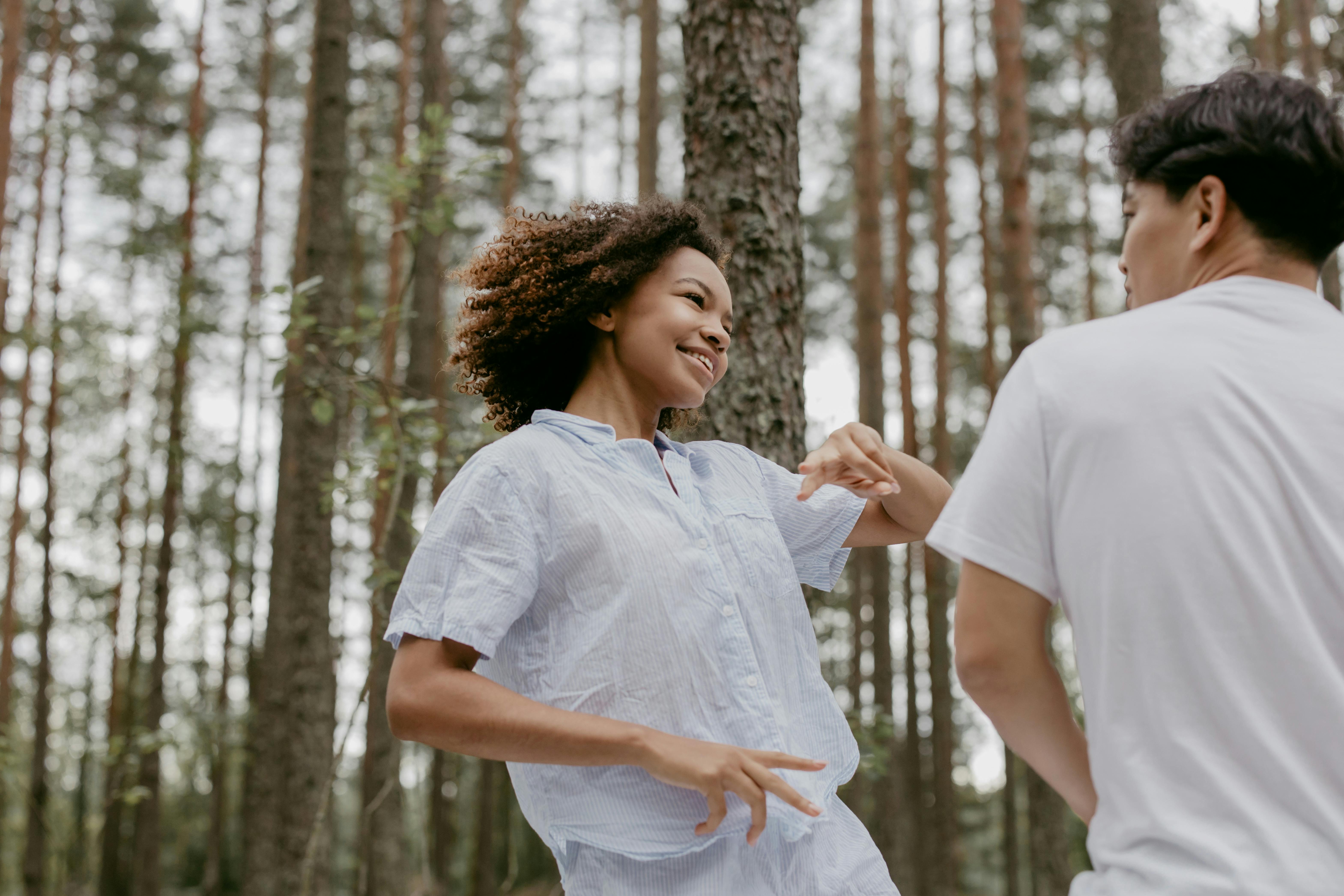 Couple Among Trees in a Forest · Free Stock Photo