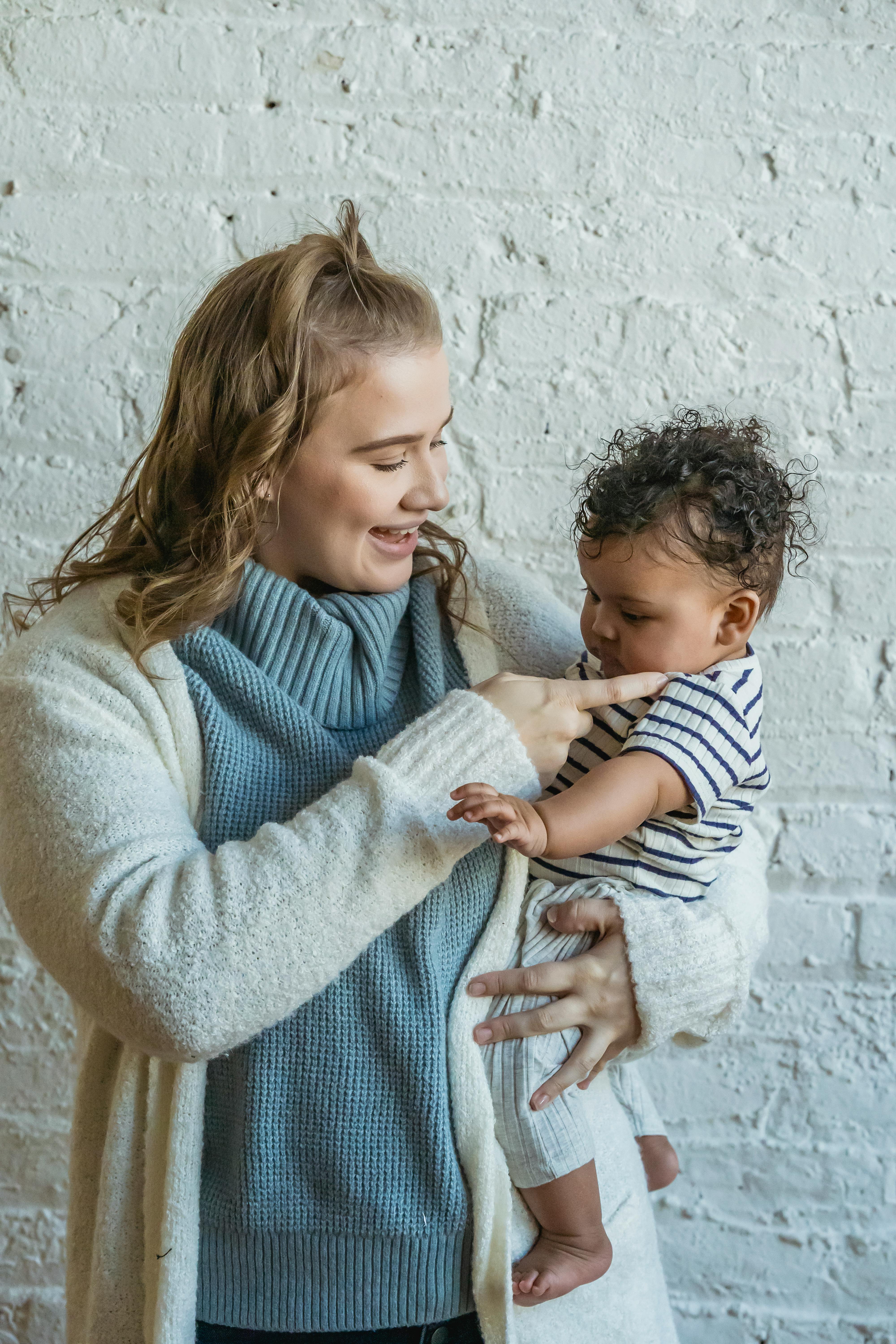 Woman Carrying her Baby · Free Stock Photo