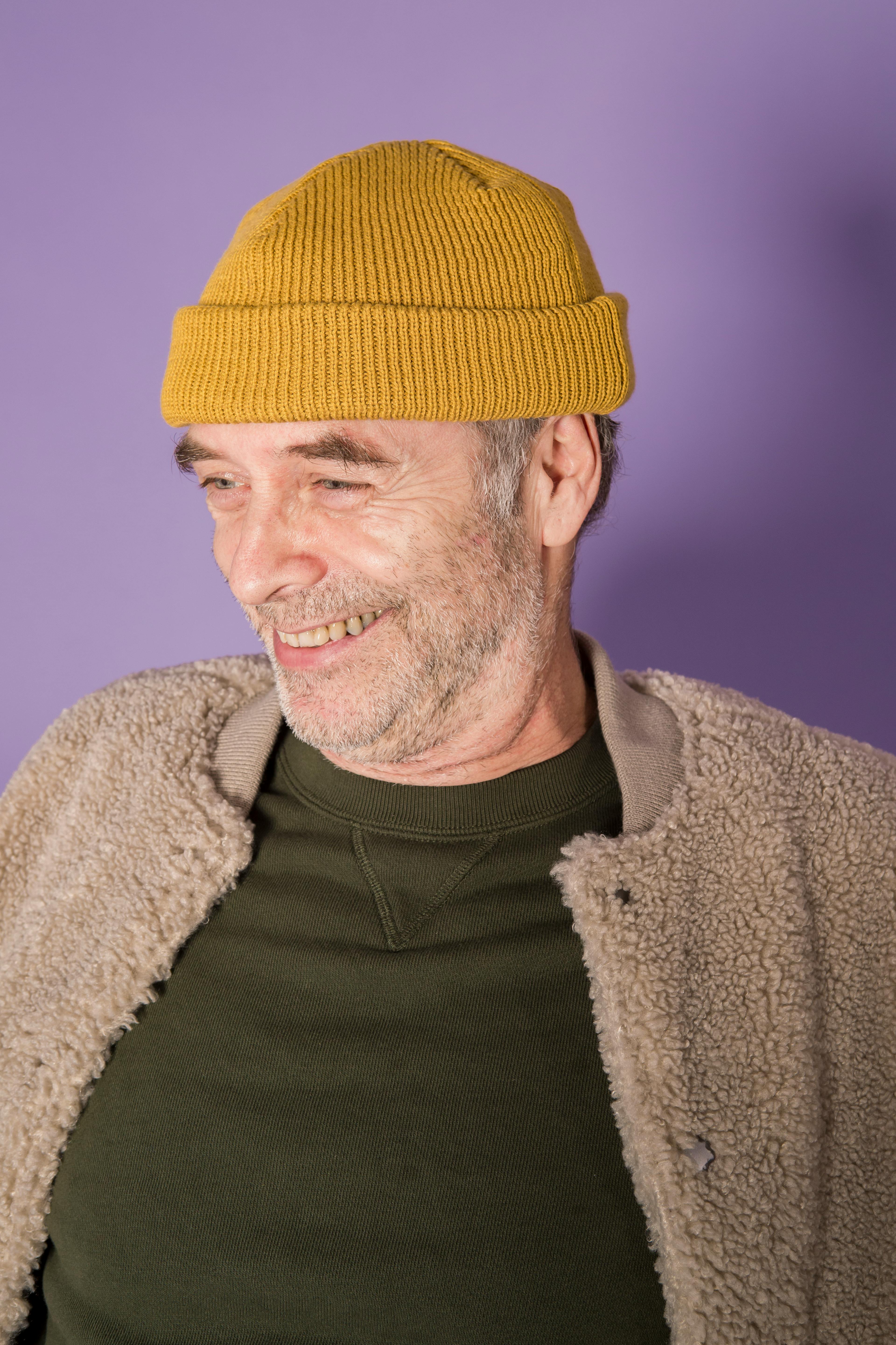 Man in Yellow Knit Cap and Brown Coat · Free Stock Photo