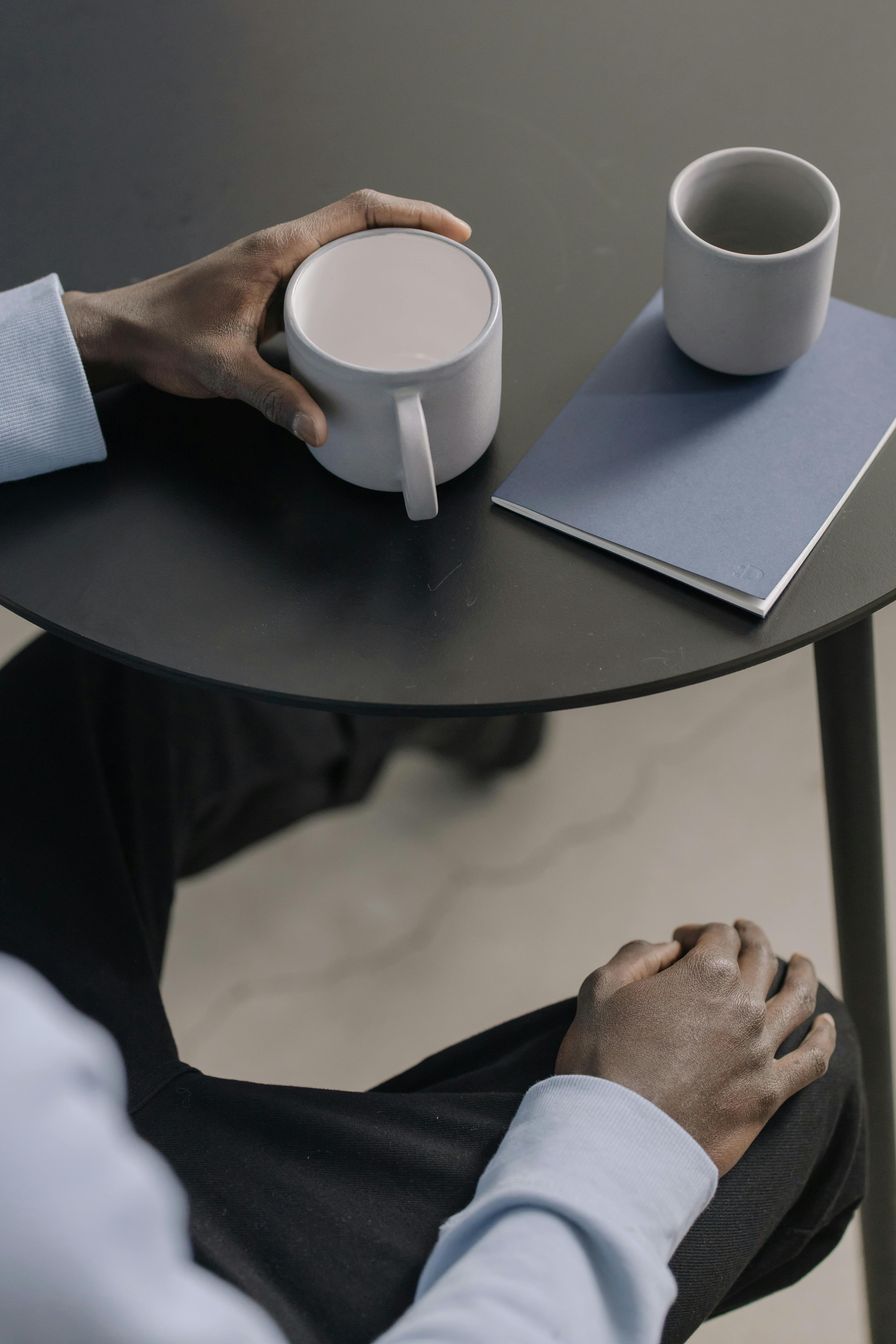A Person Holding a Clear Plastic Cup with Drinks · Free Stock Photo