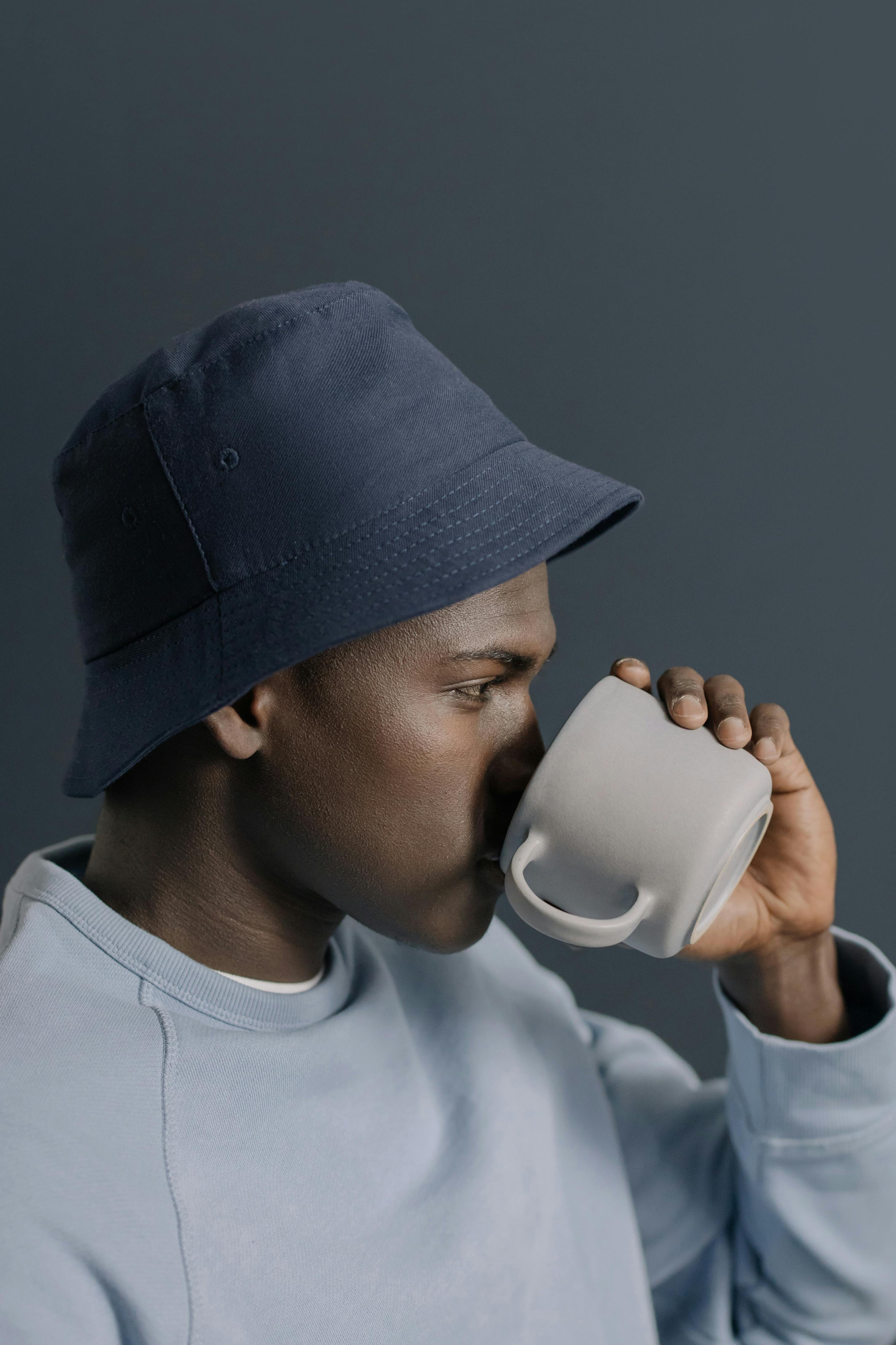 Man in Bucket Hat Covering His Face With a Book · Free Stock Photo