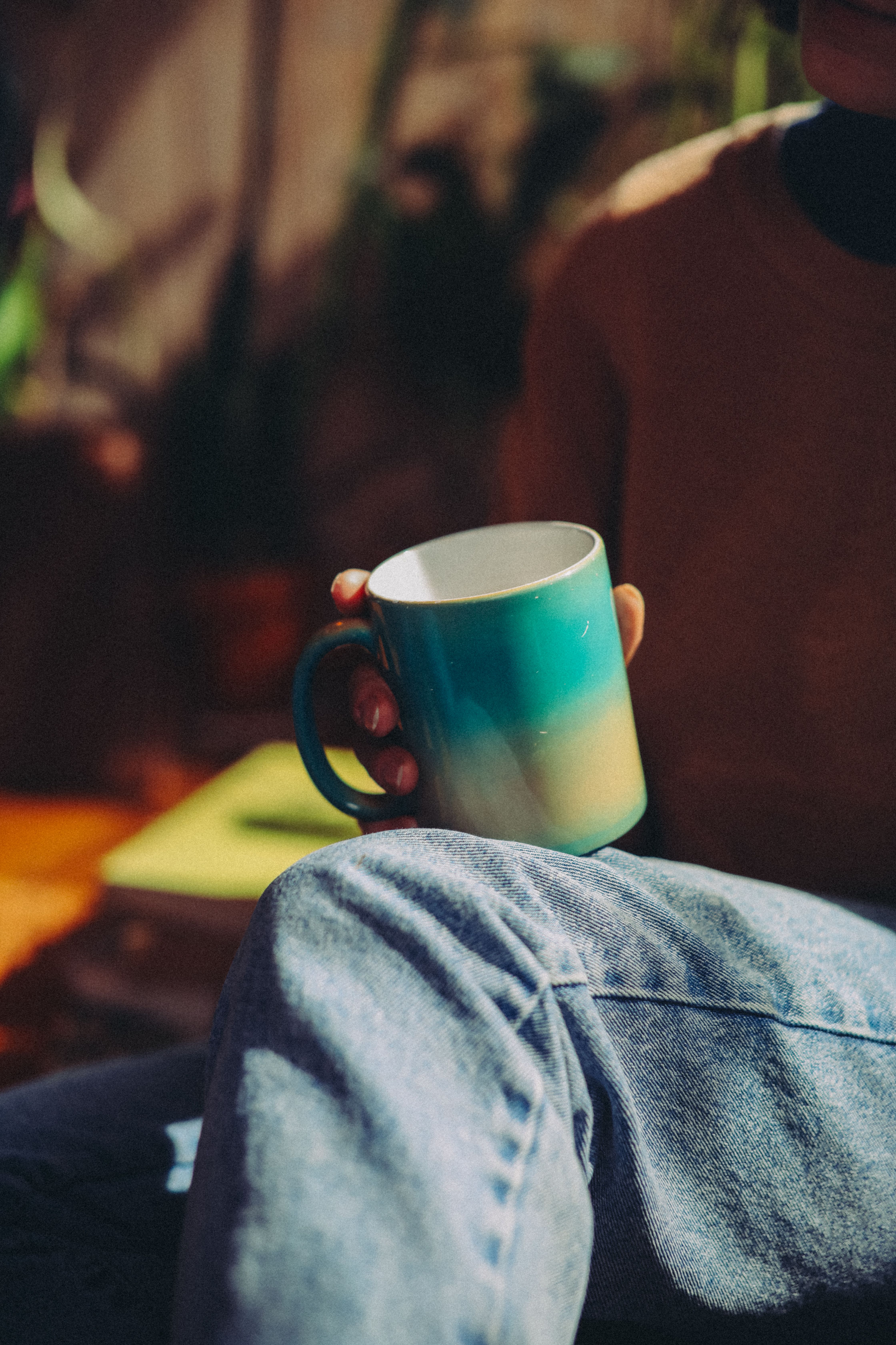 Person Wearing Blue Denim Jeans Holding a Ceramic Mug · Free Stock Photo