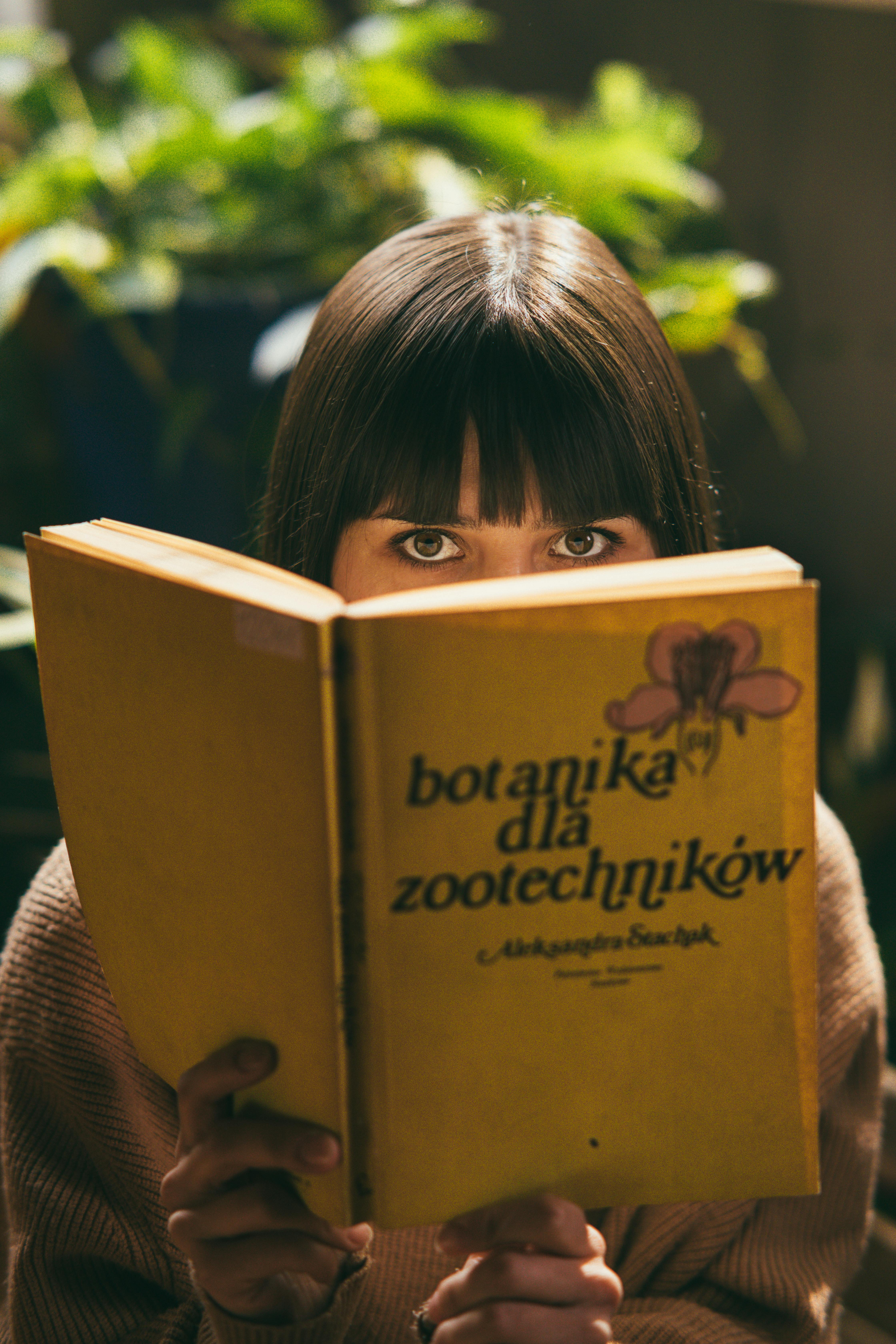 A Woman with Bangs Holding a Book · Free Stock Photo
