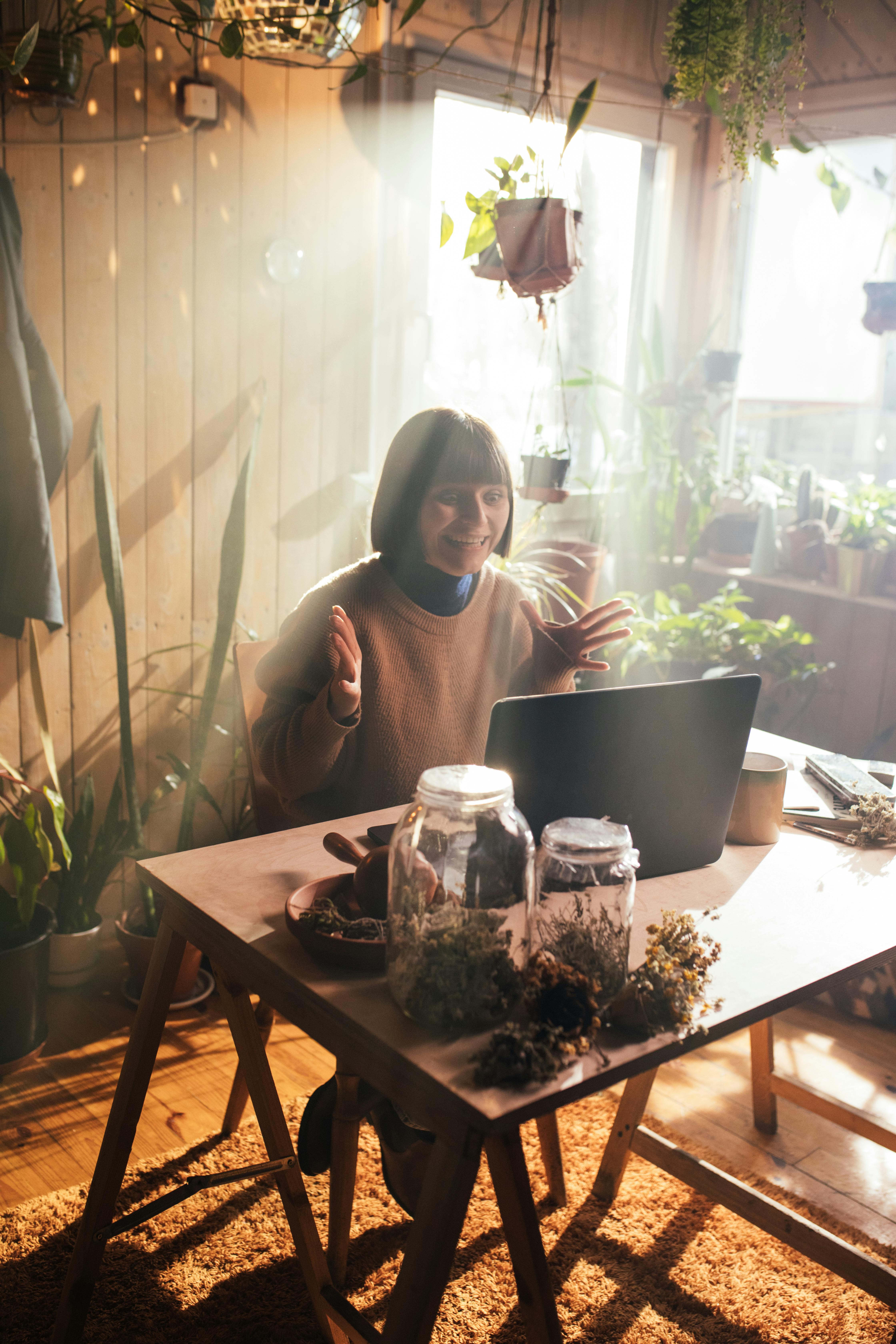 Woman Using a Laptop at a Home Garden · Free Stock Photo