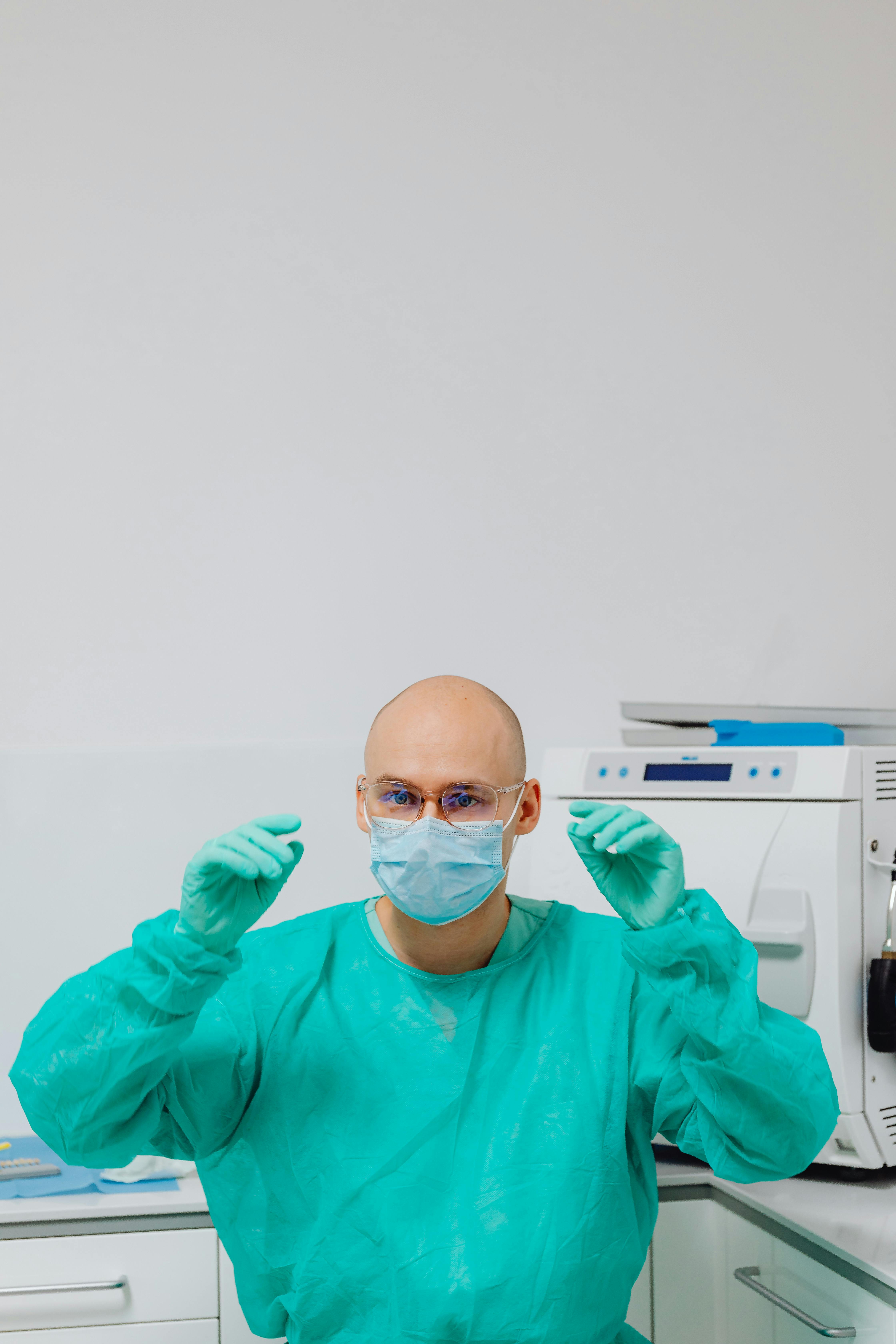A Doctor with Stethoscope Wearing Pink Face Mask while Looking at the ...