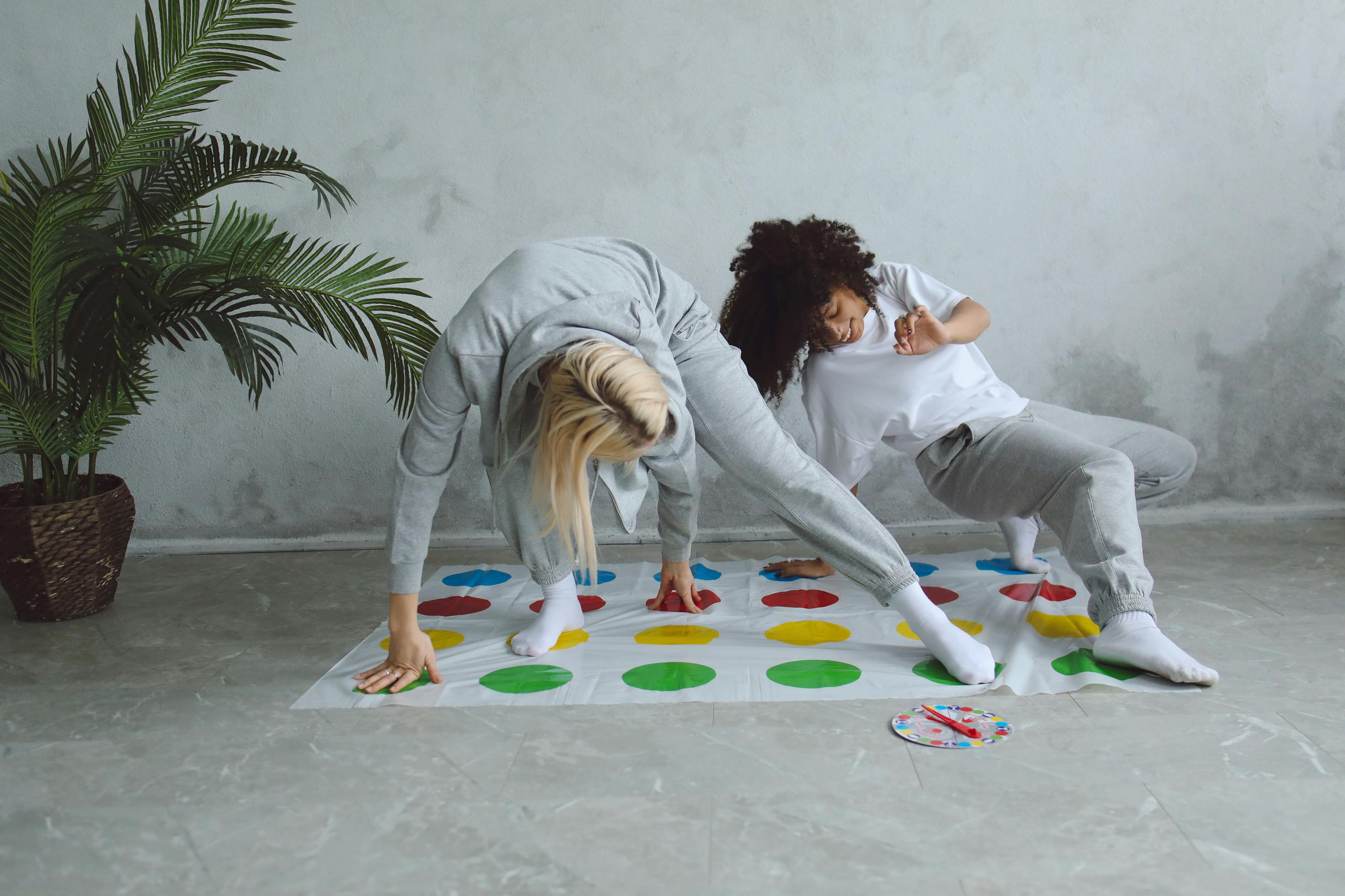 Two Women Playing a Twister Game · Free Stock Photo