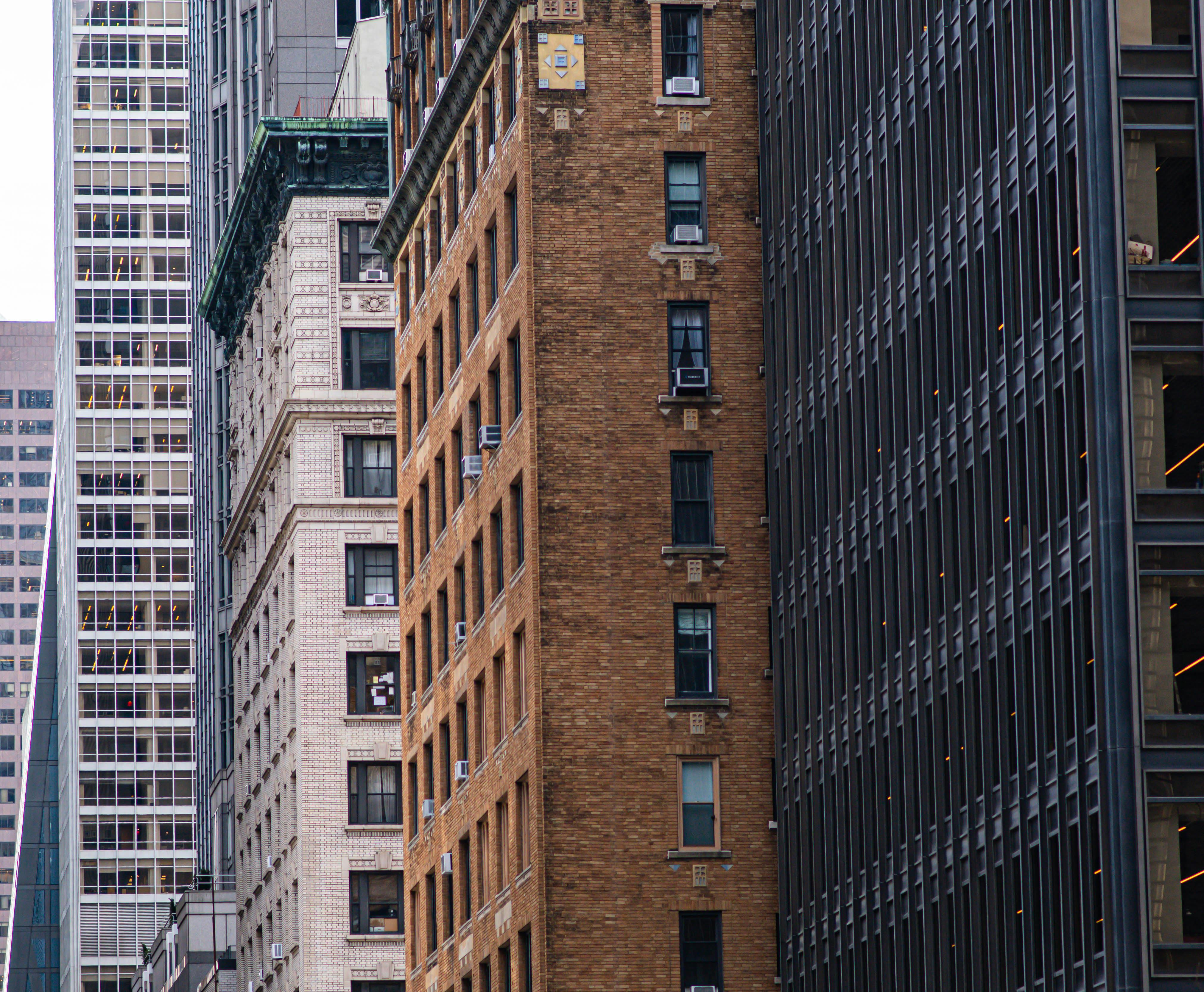 Brick Building Beside Skyscrapers · Free Stock Photo