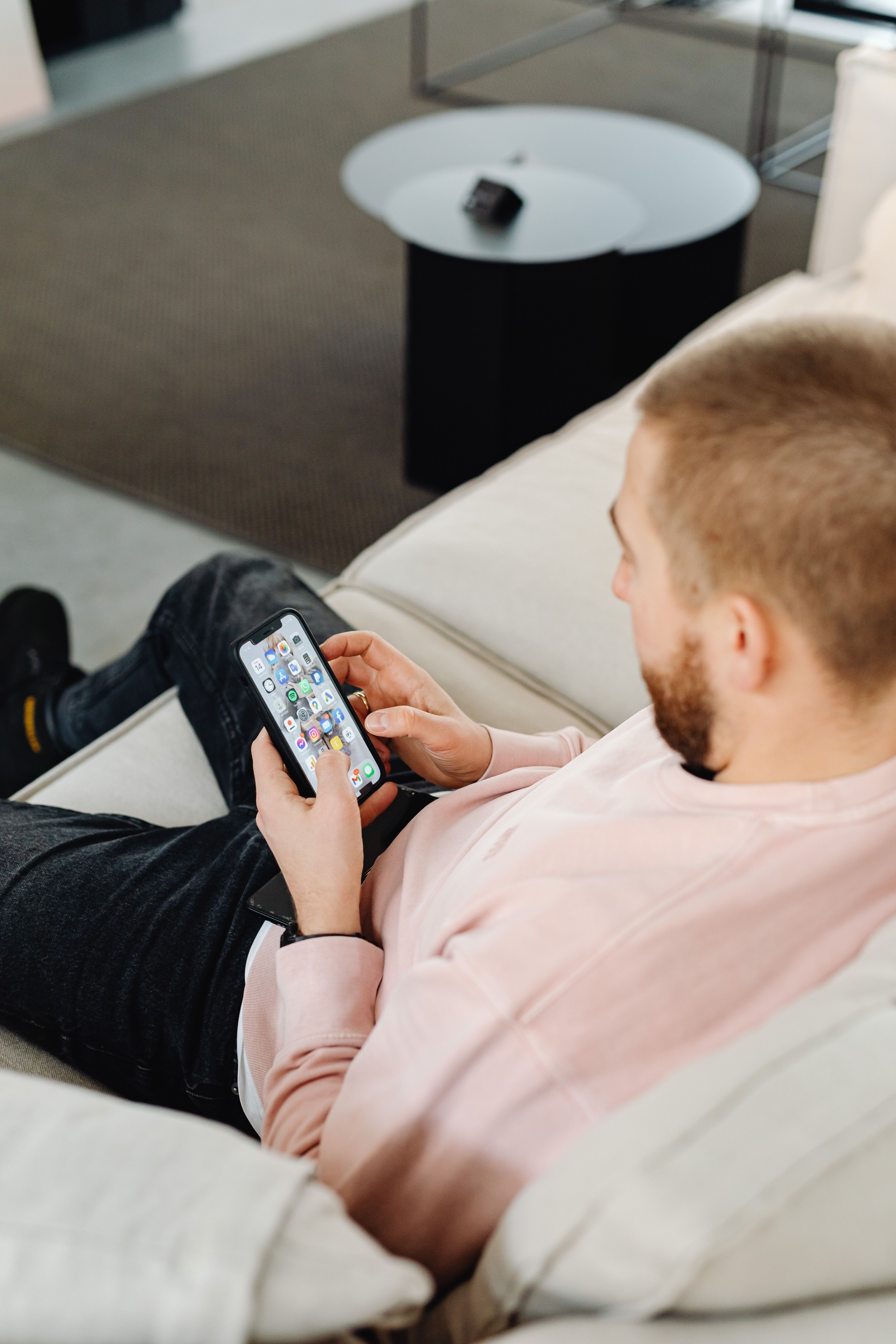Man Sitting While Using His Smartphone · Free Stock Photo