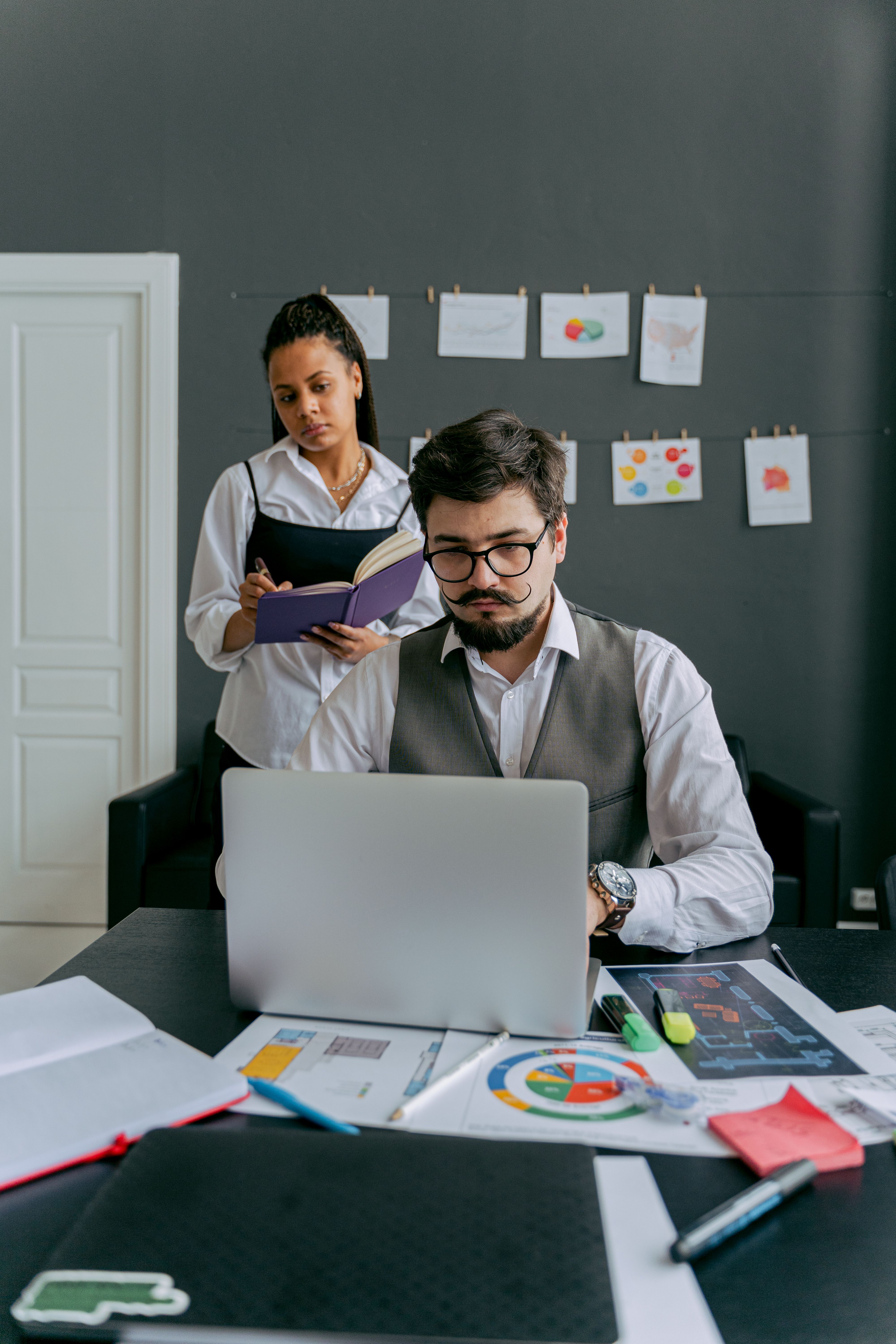 Photo of a Woman Watching a Man with a Moustache Work · Free Stock Photo