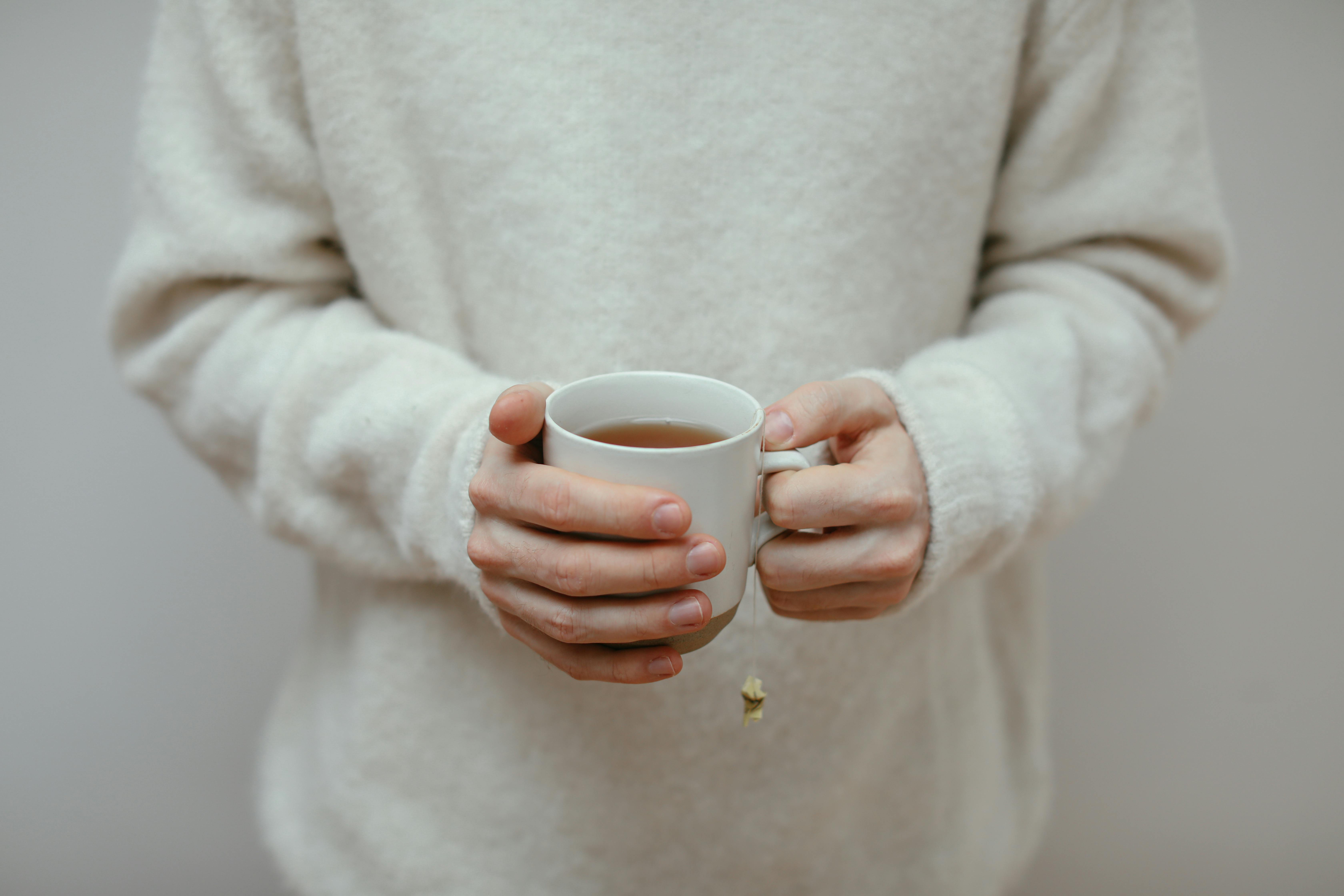 Close Up Photo of a Person Holding Cup of Tea · Free Stock Photo