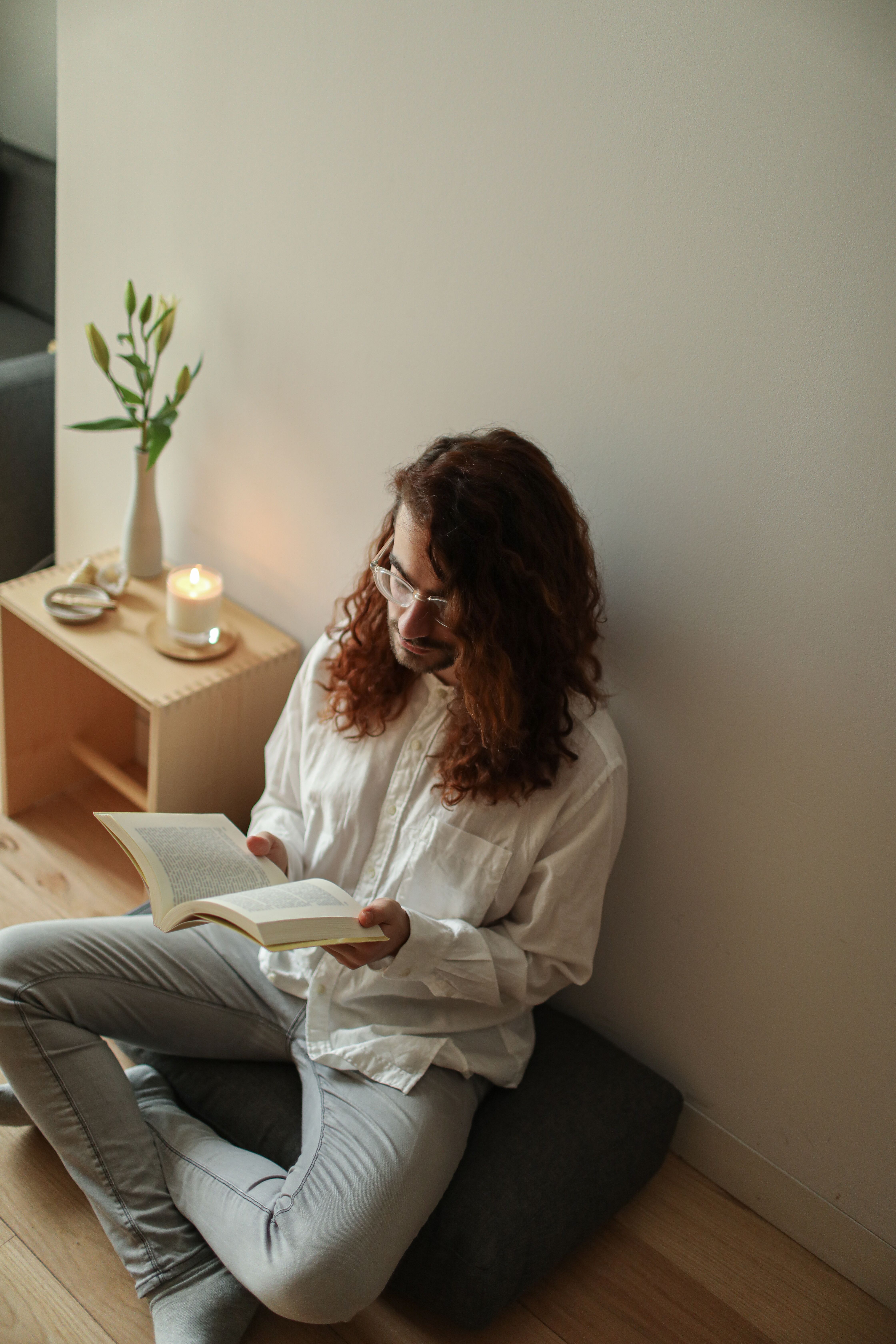 A Young Woman Writing in a Notebook While Sitting on a Couch · Free ...