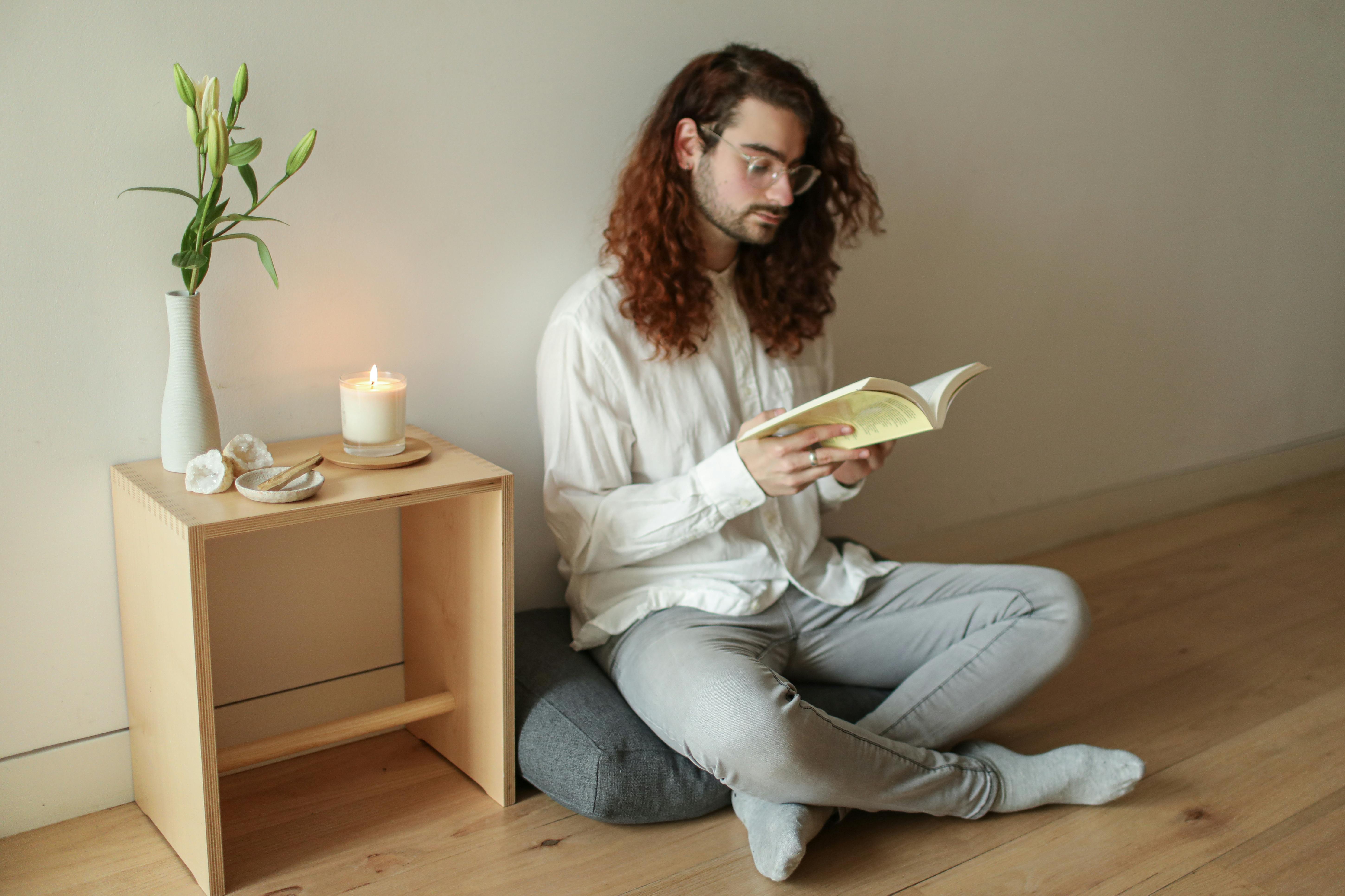Man Reading a Book While Sitting on the Floor · Free Stock Photo