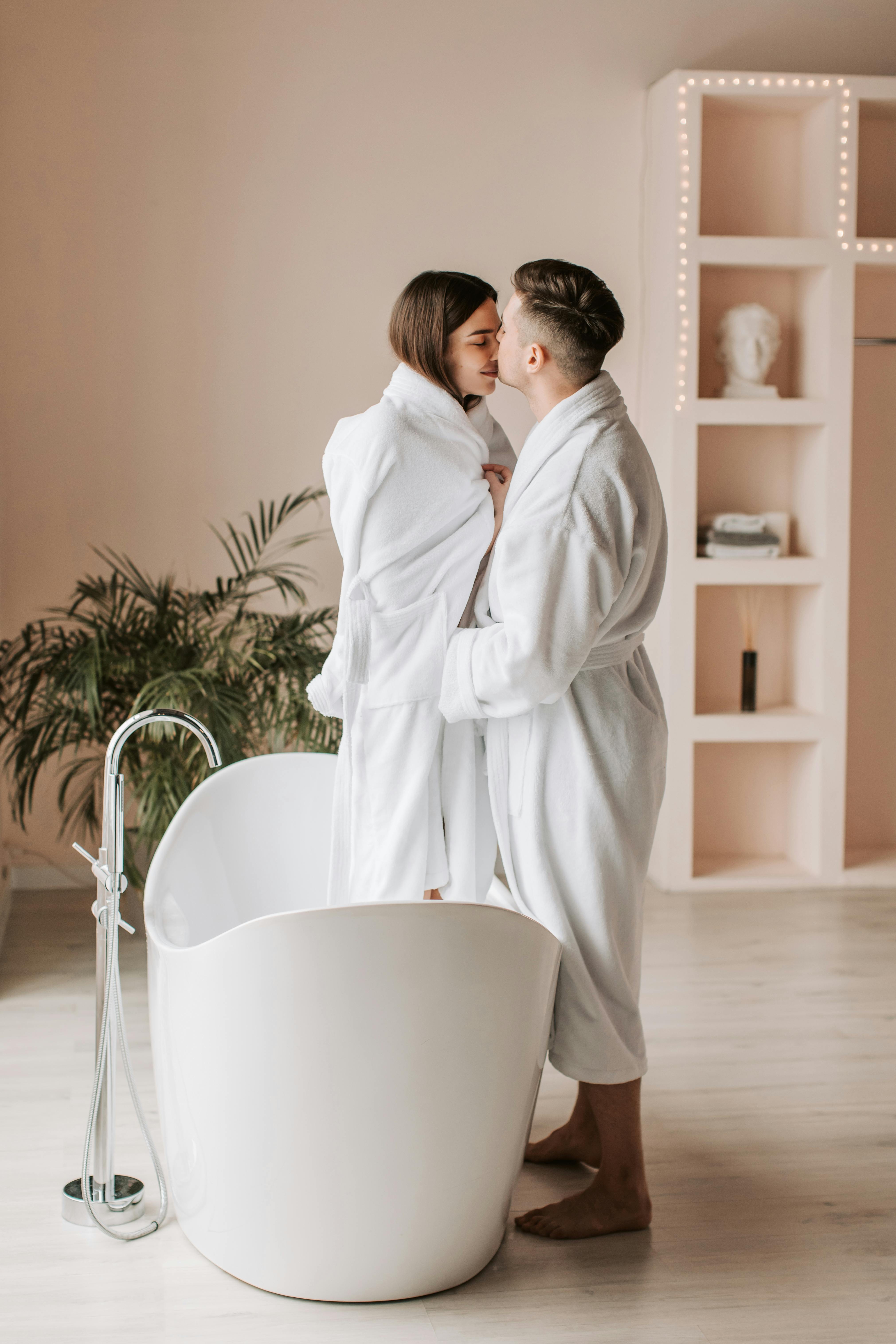 A Couple Wearing Bathrobe Kissing in the Bathroom · Free Stock Photo