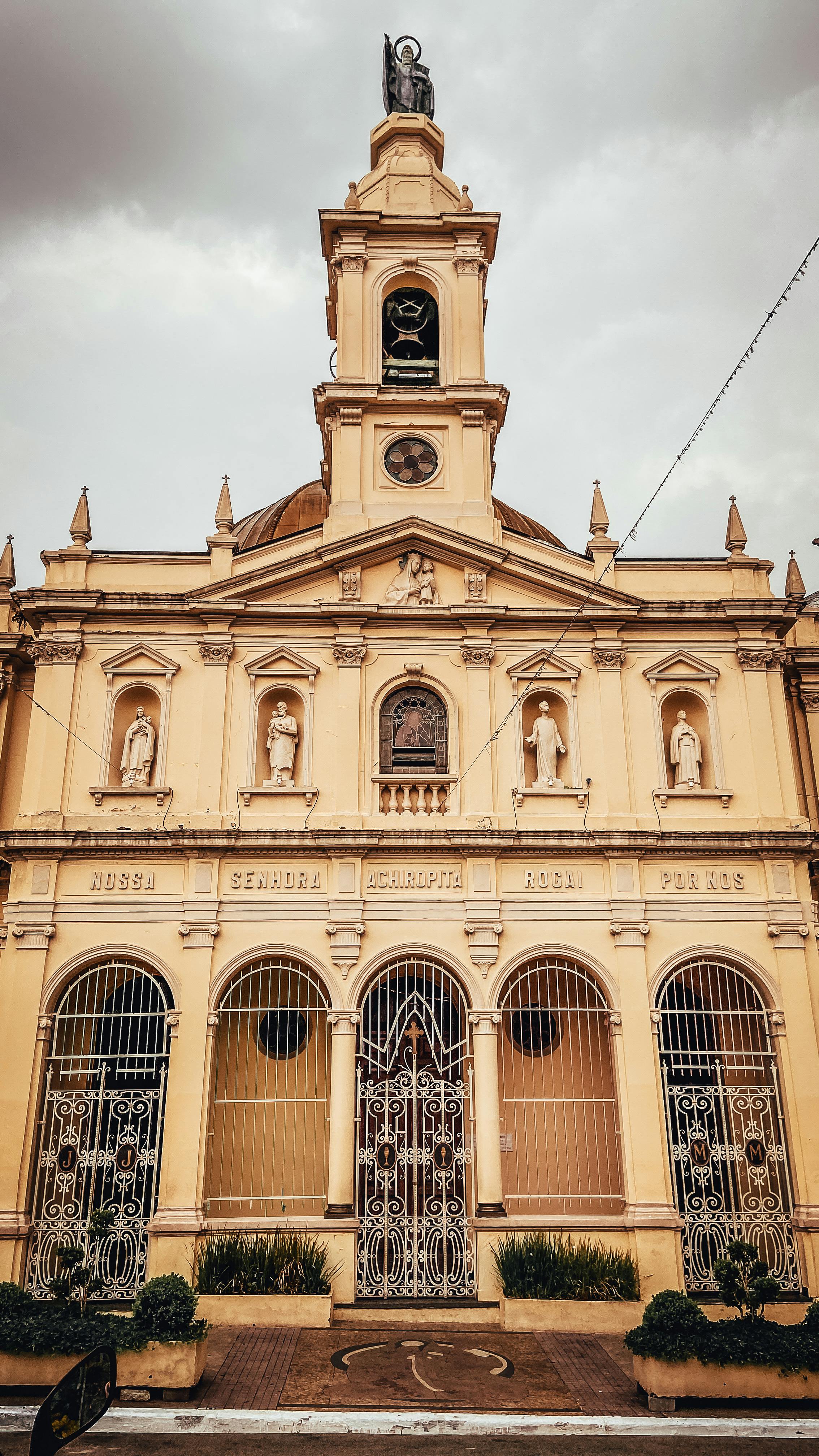 Arched tower of old Catholic church against cloudless blue sky · Free ...