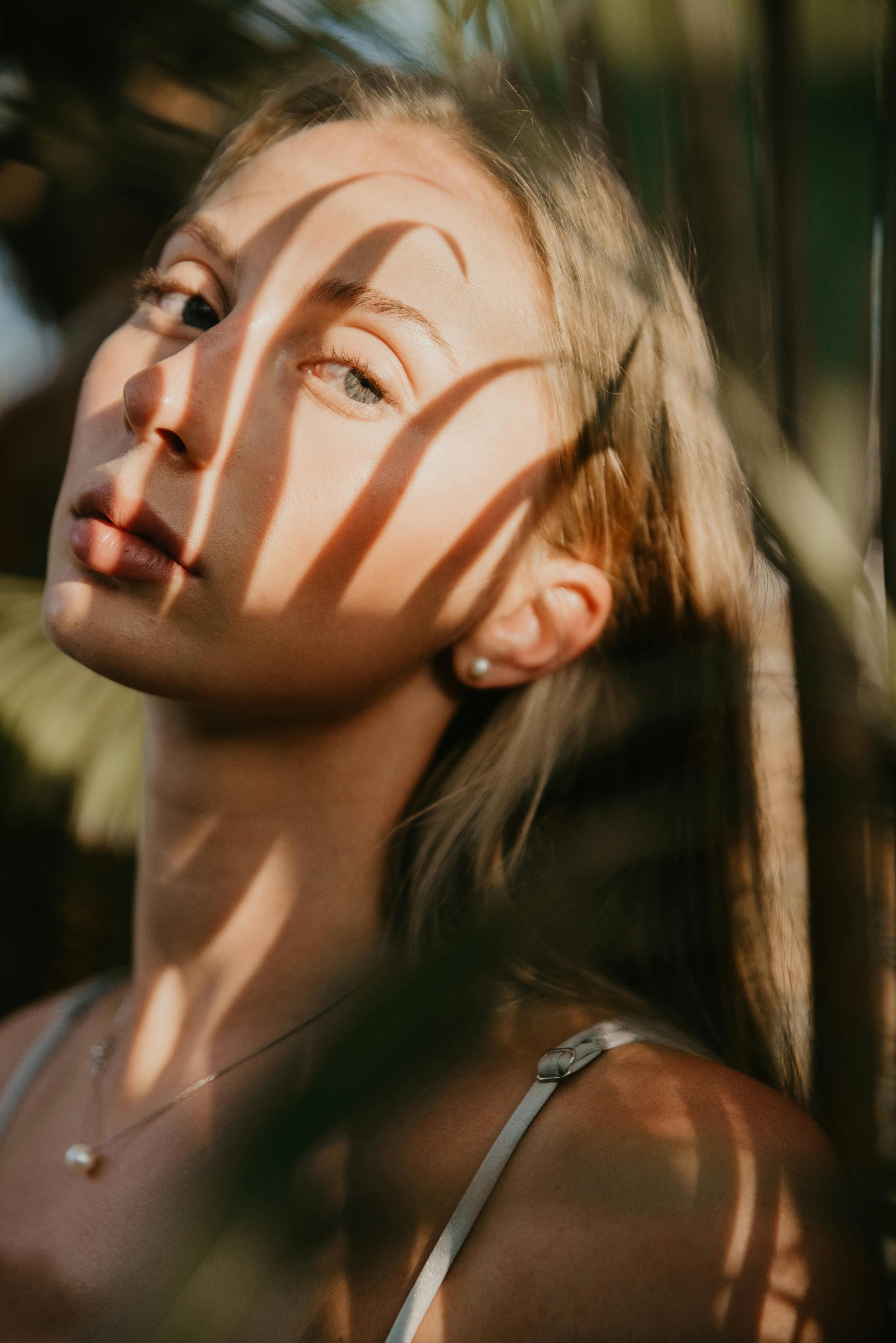 A Close-up Shot of a Woman with Shadows on Her Face · Free Stock Photo