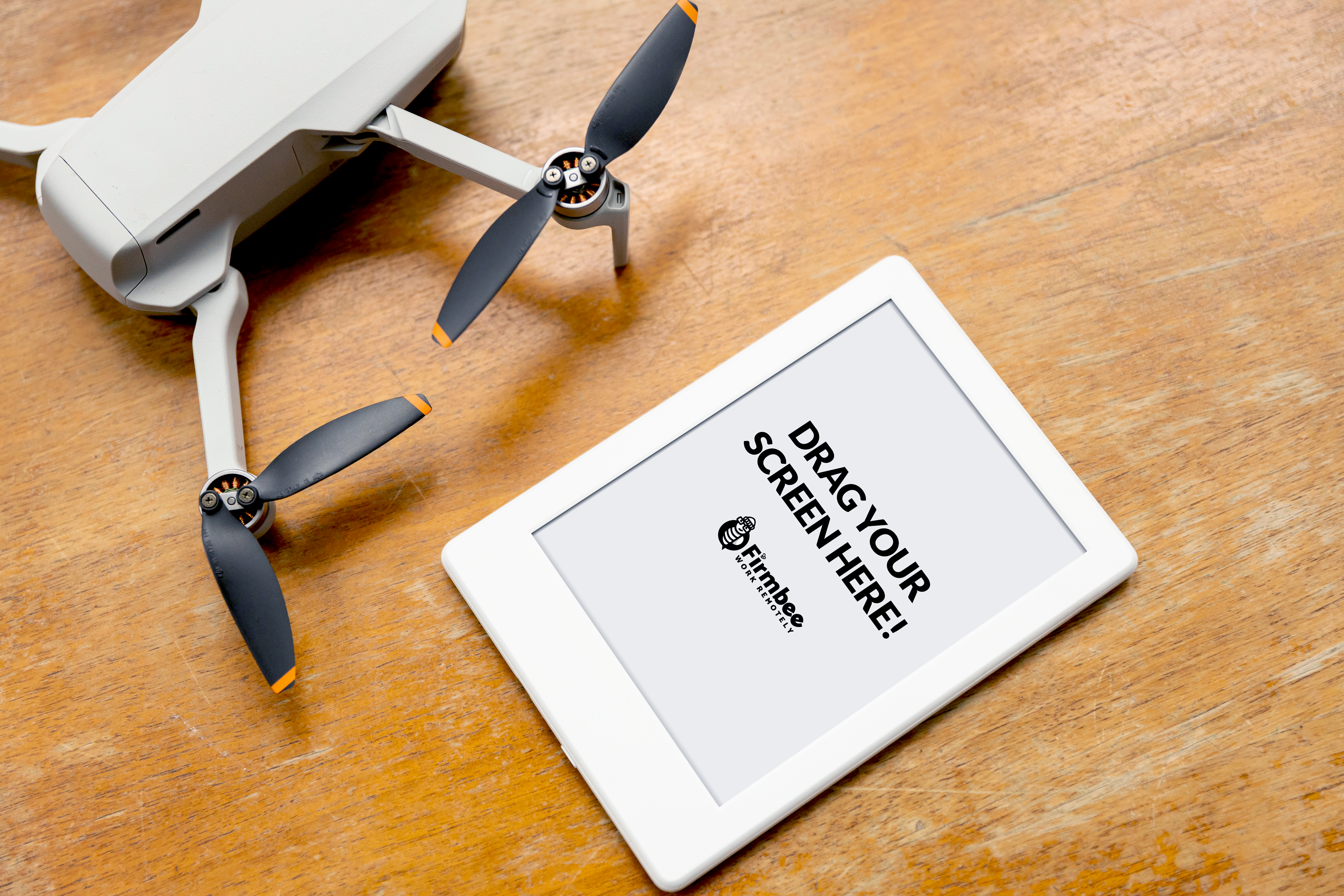 Drone and Ipad on Brown Wooden Surface · Free Stock Photo