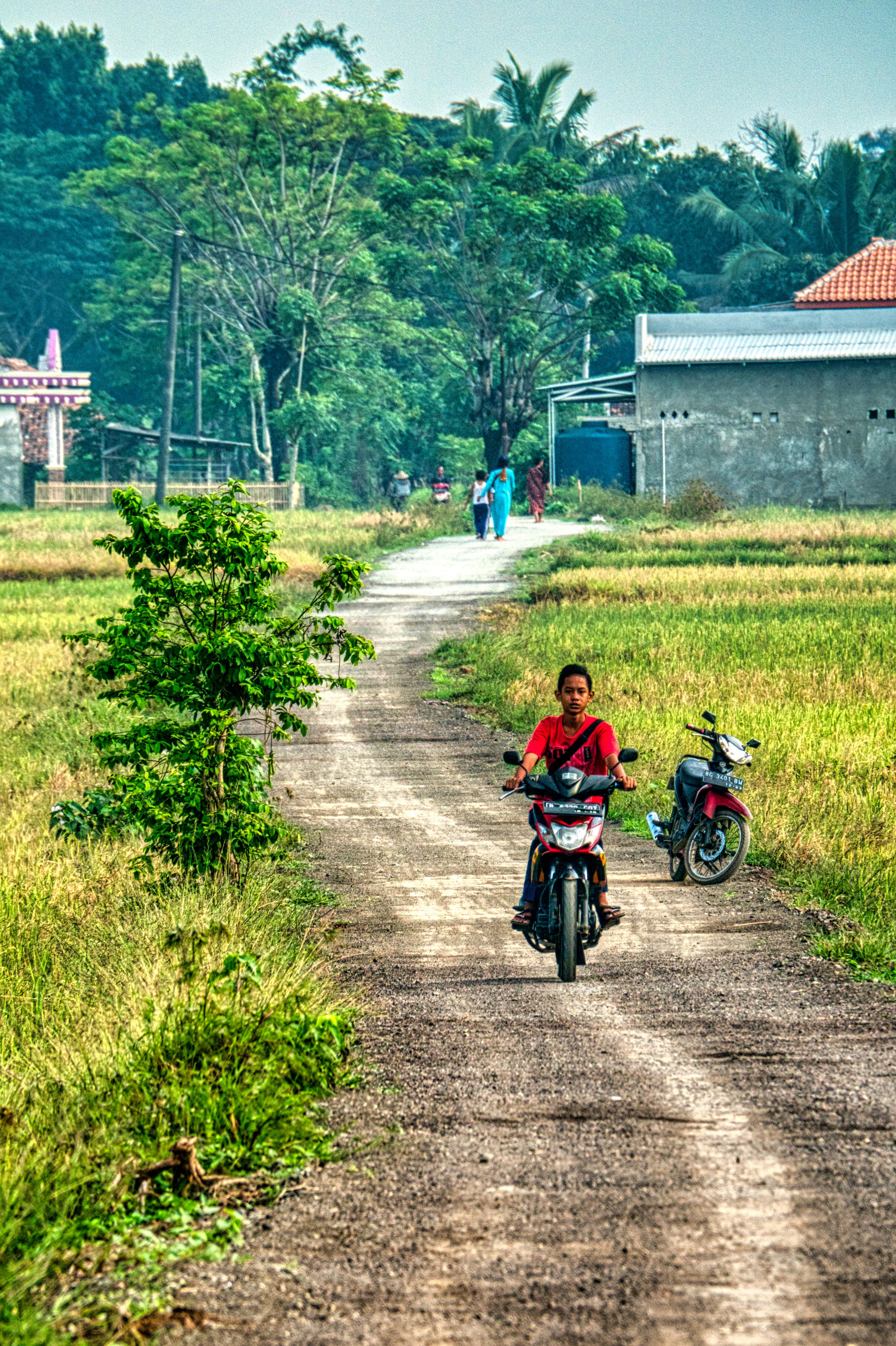 Boy Riding a Scooter in a Rural Area in Asia · Free Stock Photo