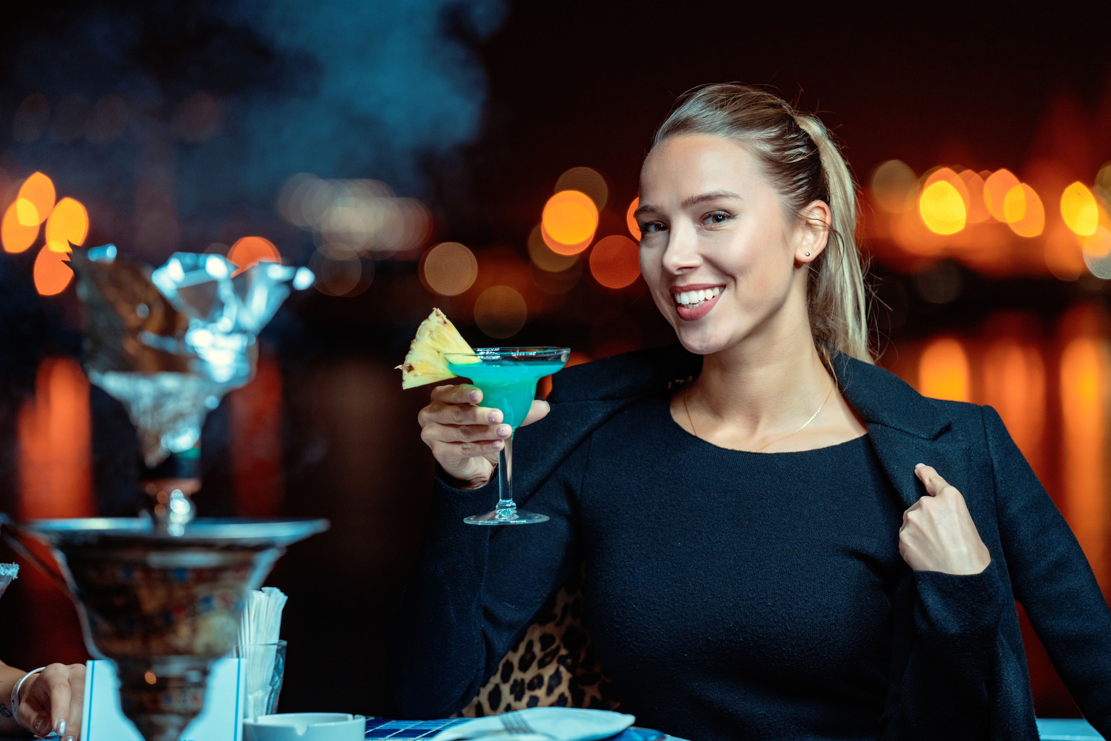 A Woman Holding a Cocktail · Free Stock Photo