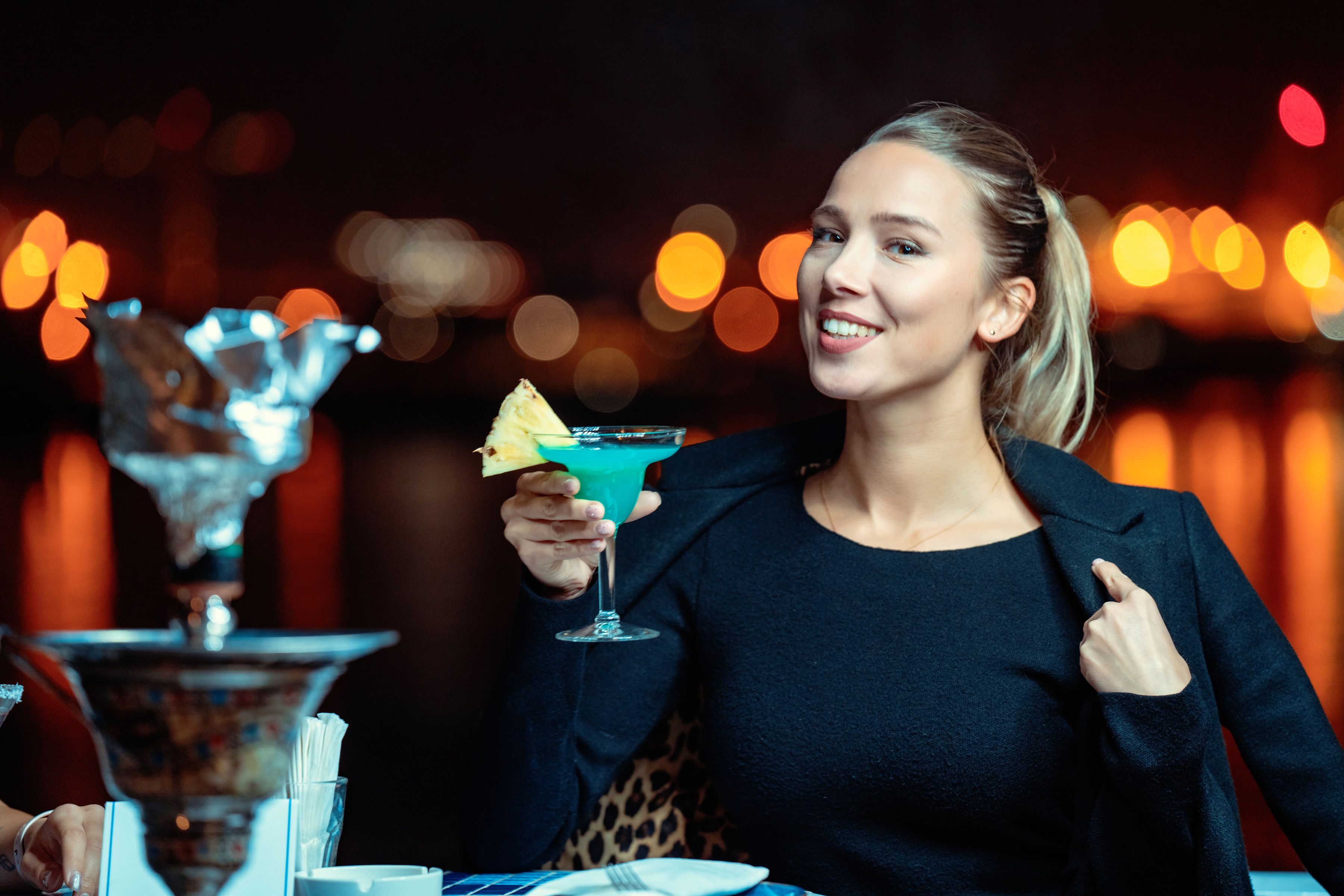 A Woman Holding a Cocktail · Free Stock Photo