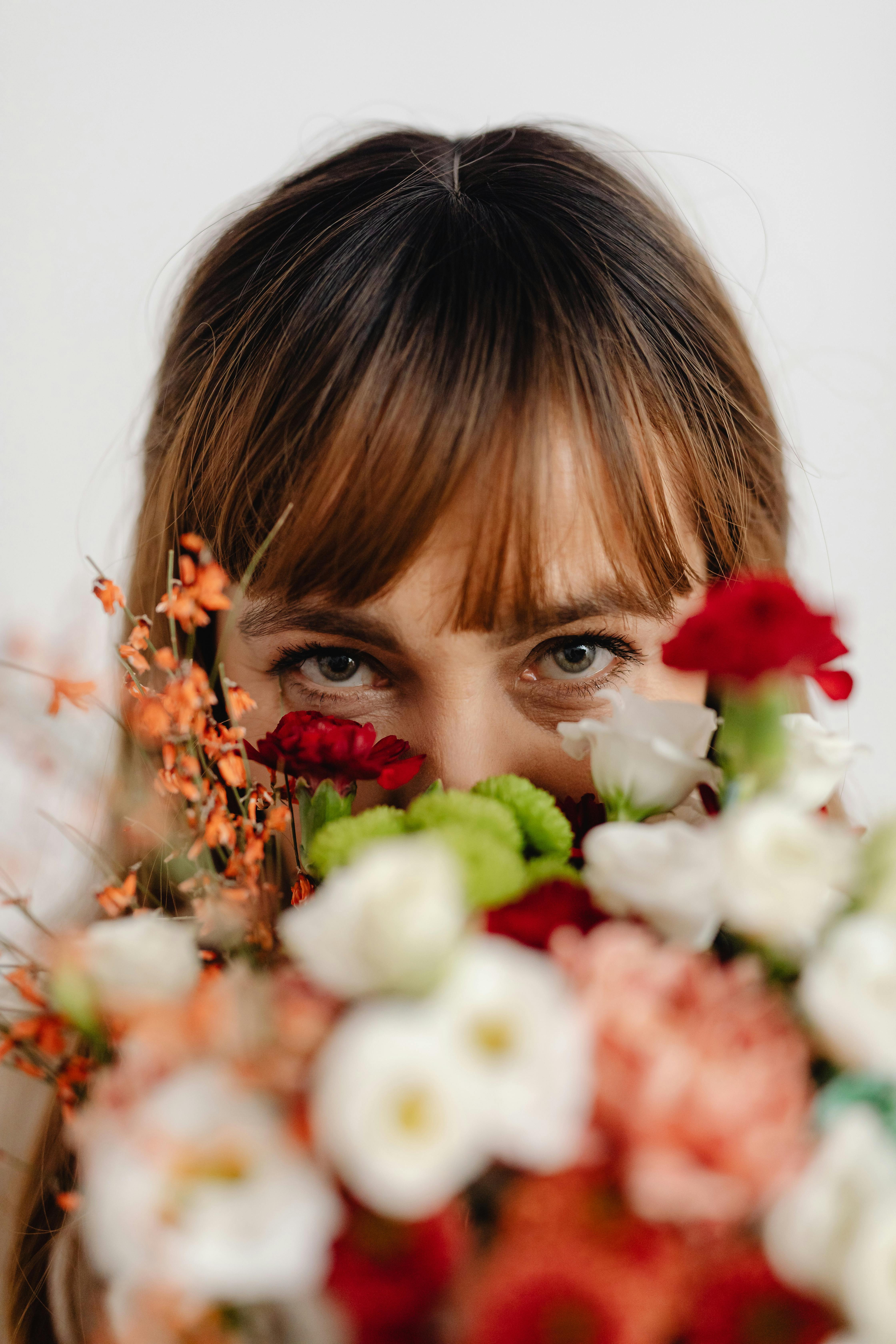 Woman's Face Covered with Red and White Flowers · Free Stock Photo