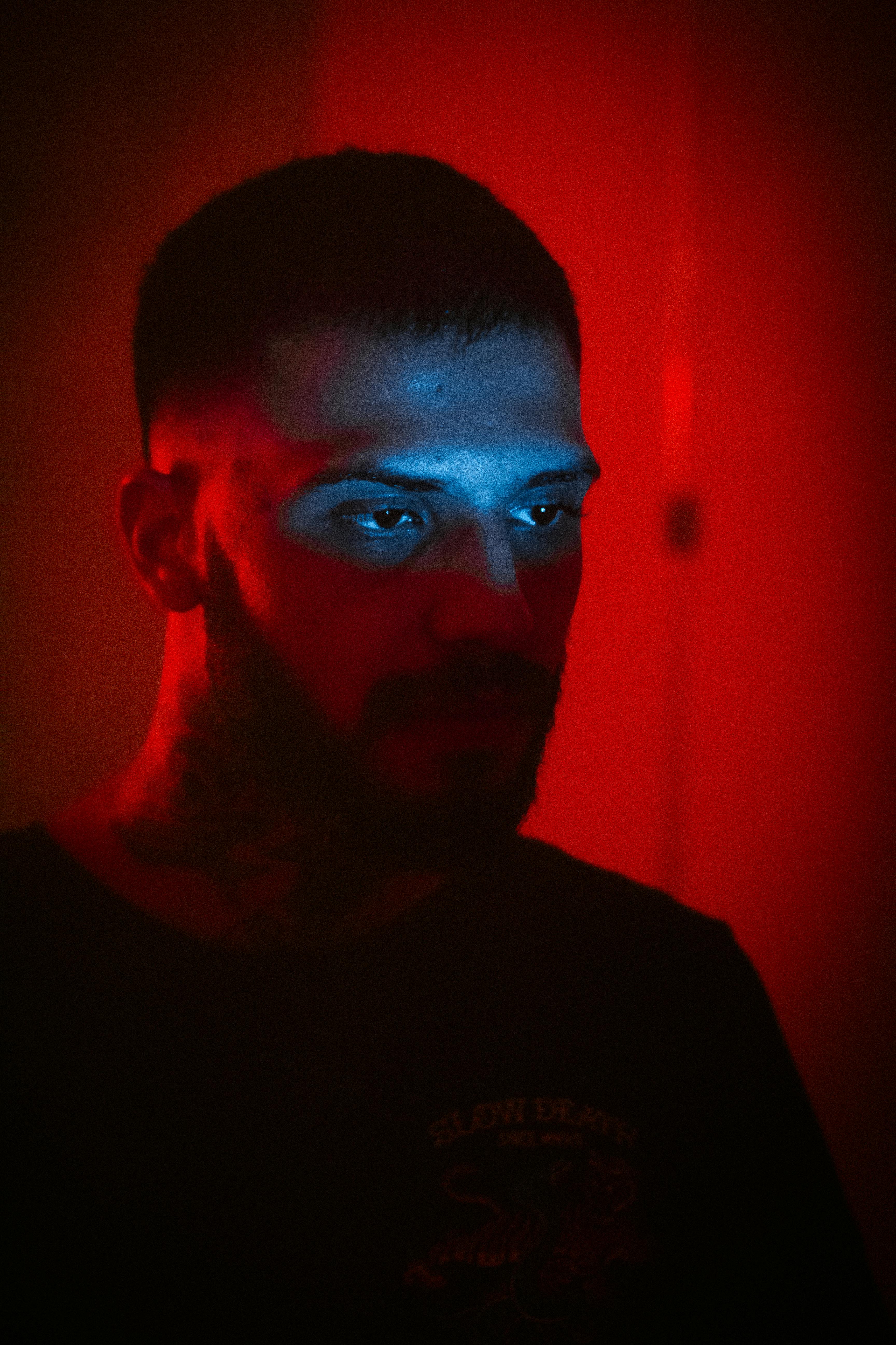 Portrait of a Man in Red Light with Blue Light Hitting His Eyes · Free ...