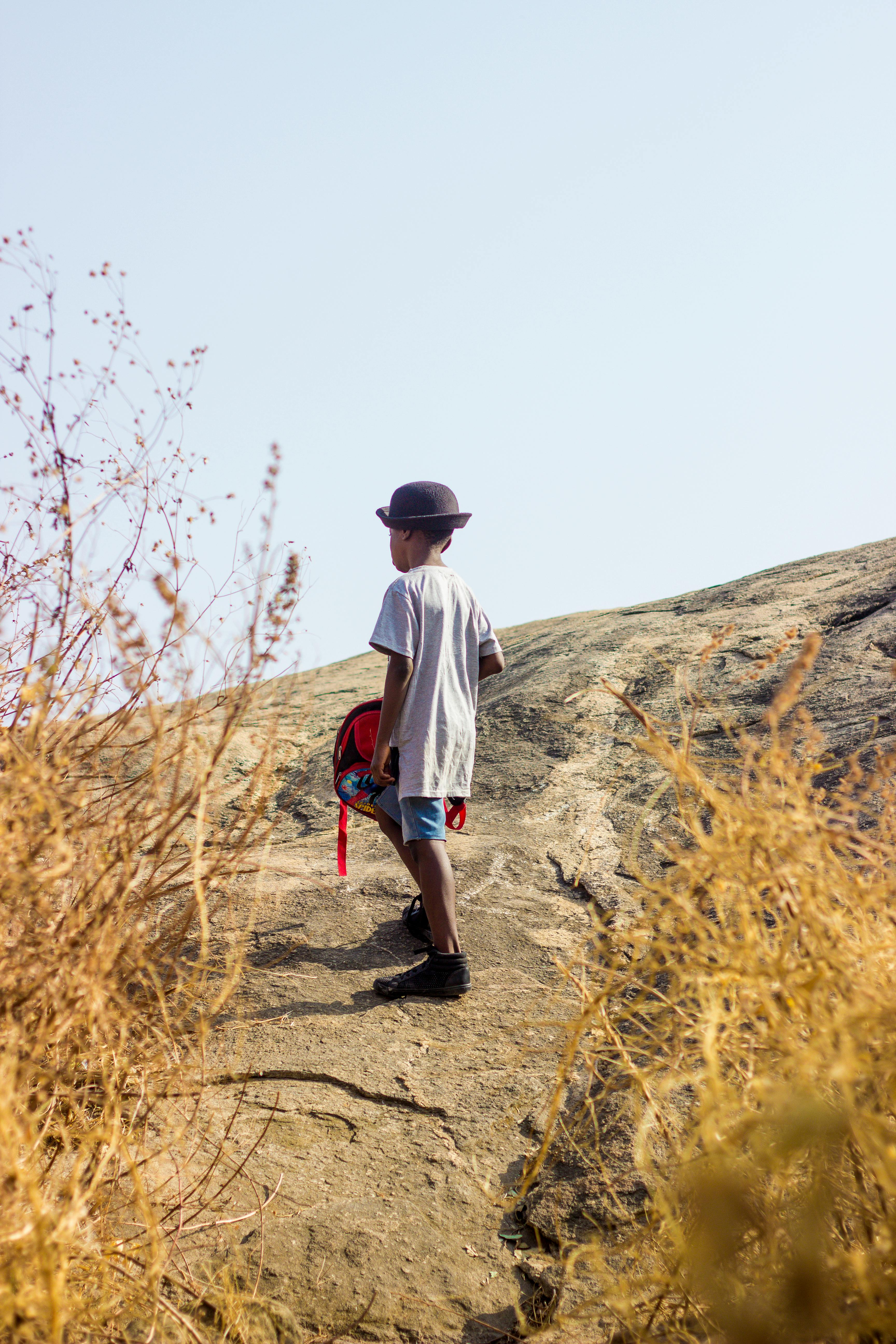 A Boy Walking on the Rock Formation · Free Stock Photo