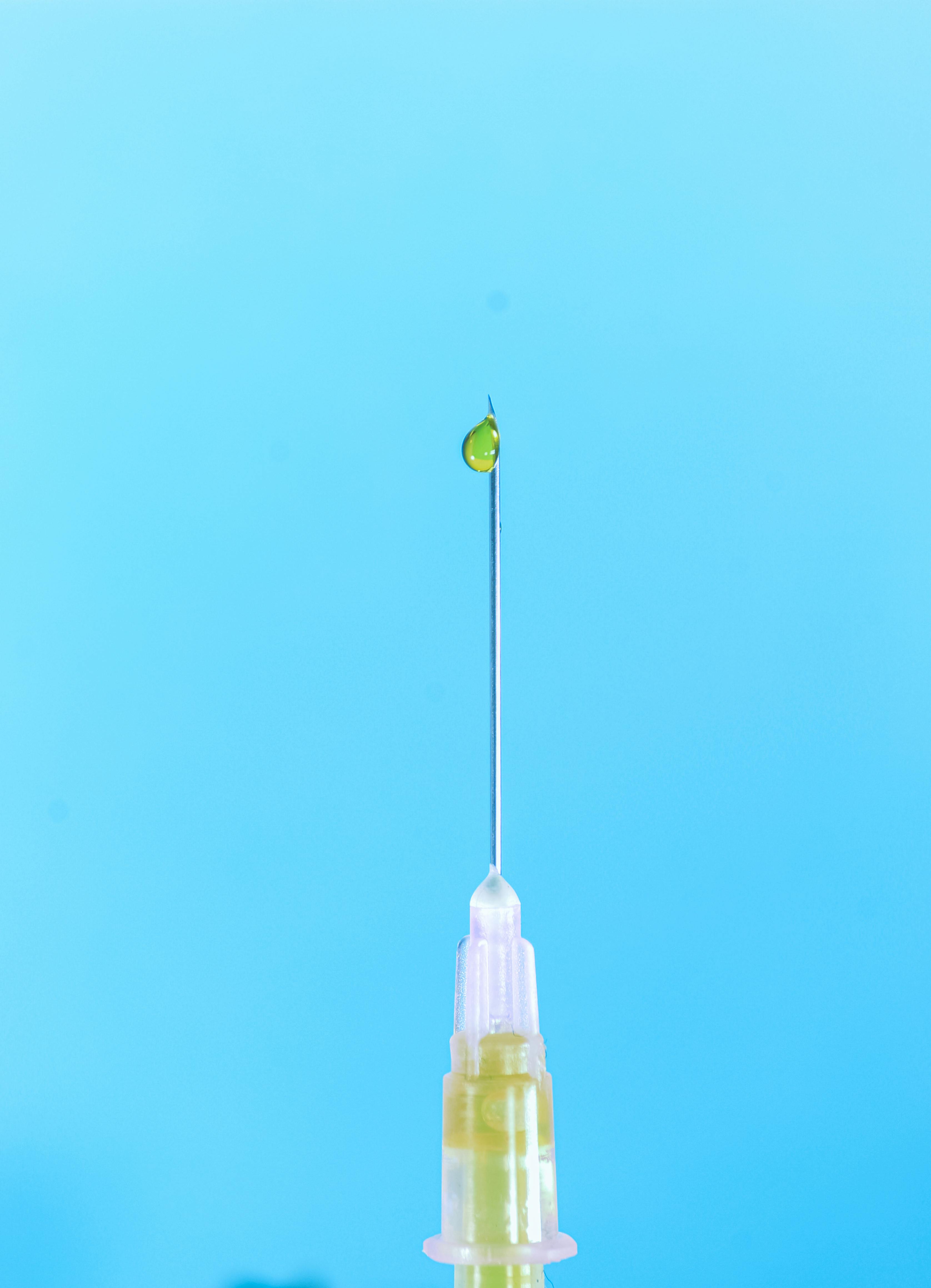 A Woman Biting a Syringe · Free Stock Photo
