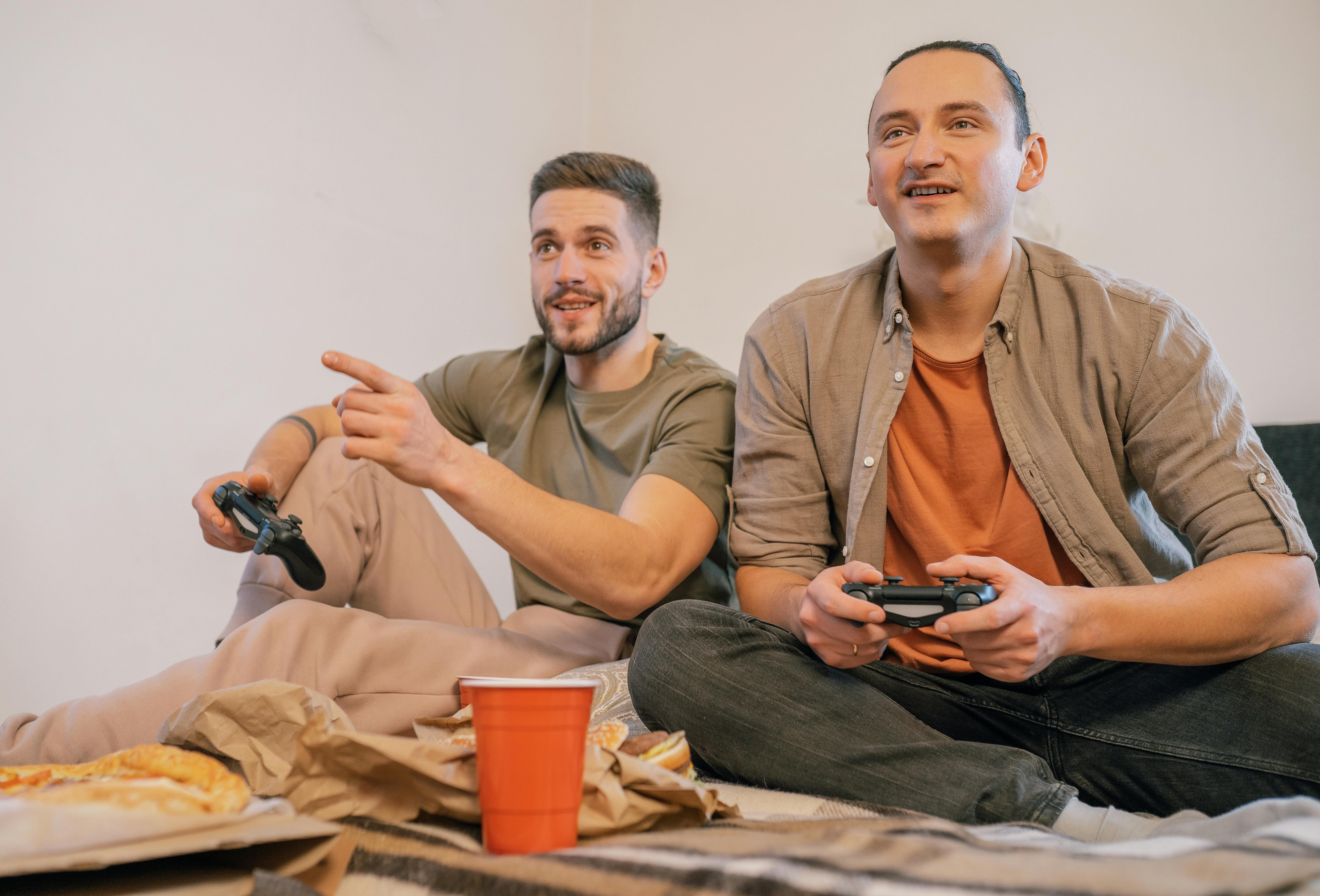Two Men Playing Video Games while Sitting · Free Stock Photo