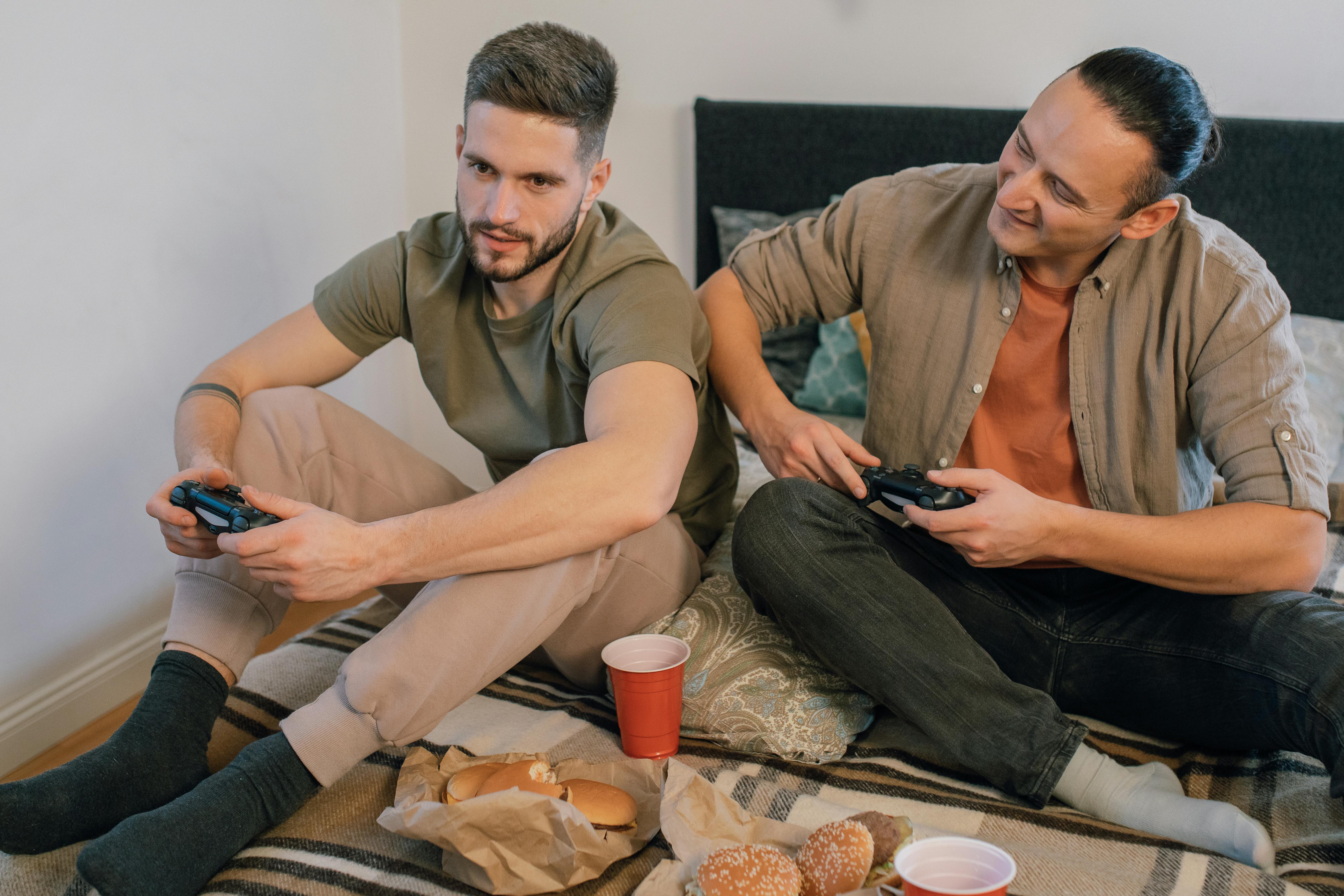 Two Men Playing Video Games while Sitting · Free Stock Photo