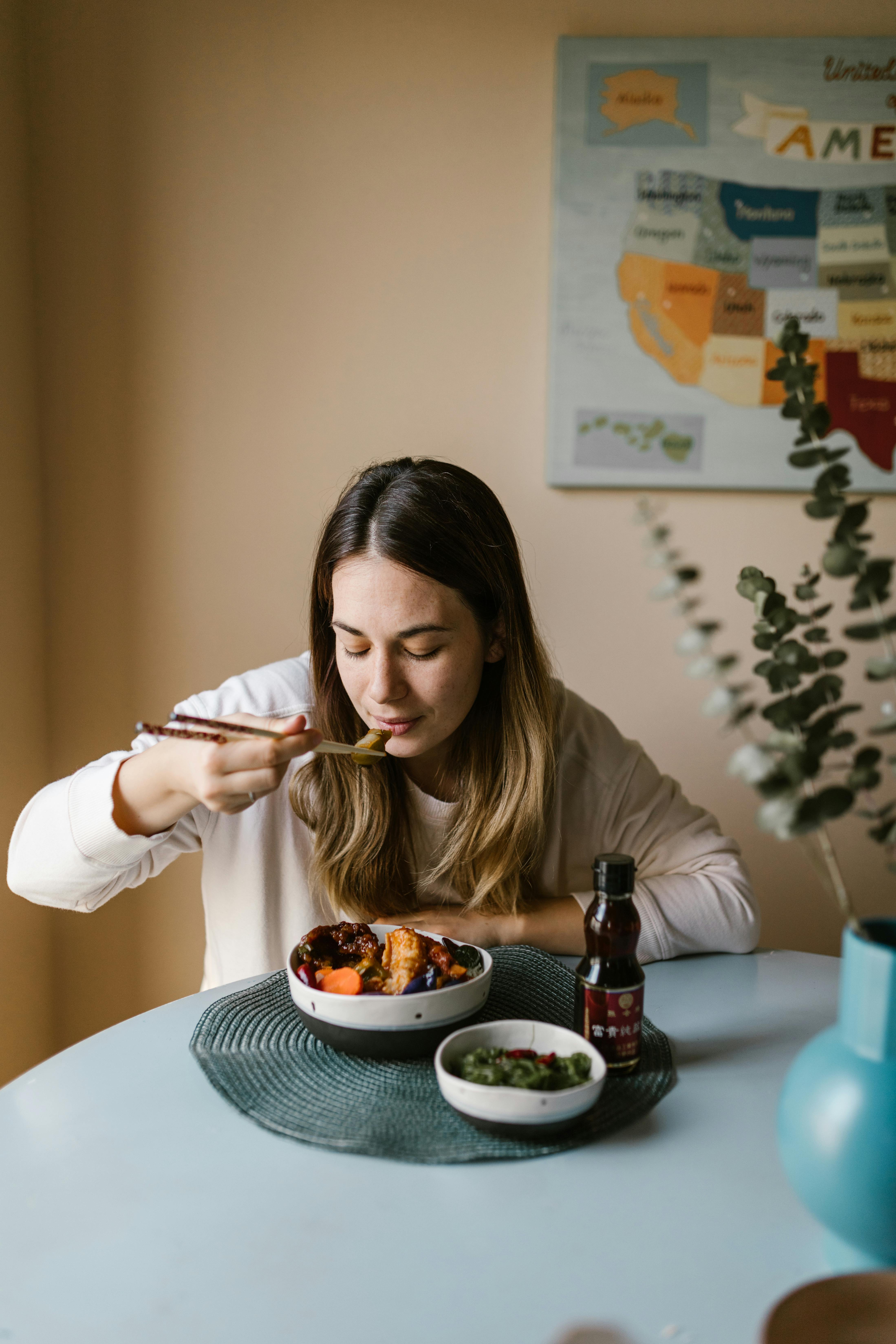 A Woman Eating at the Table · Free Stock Photo