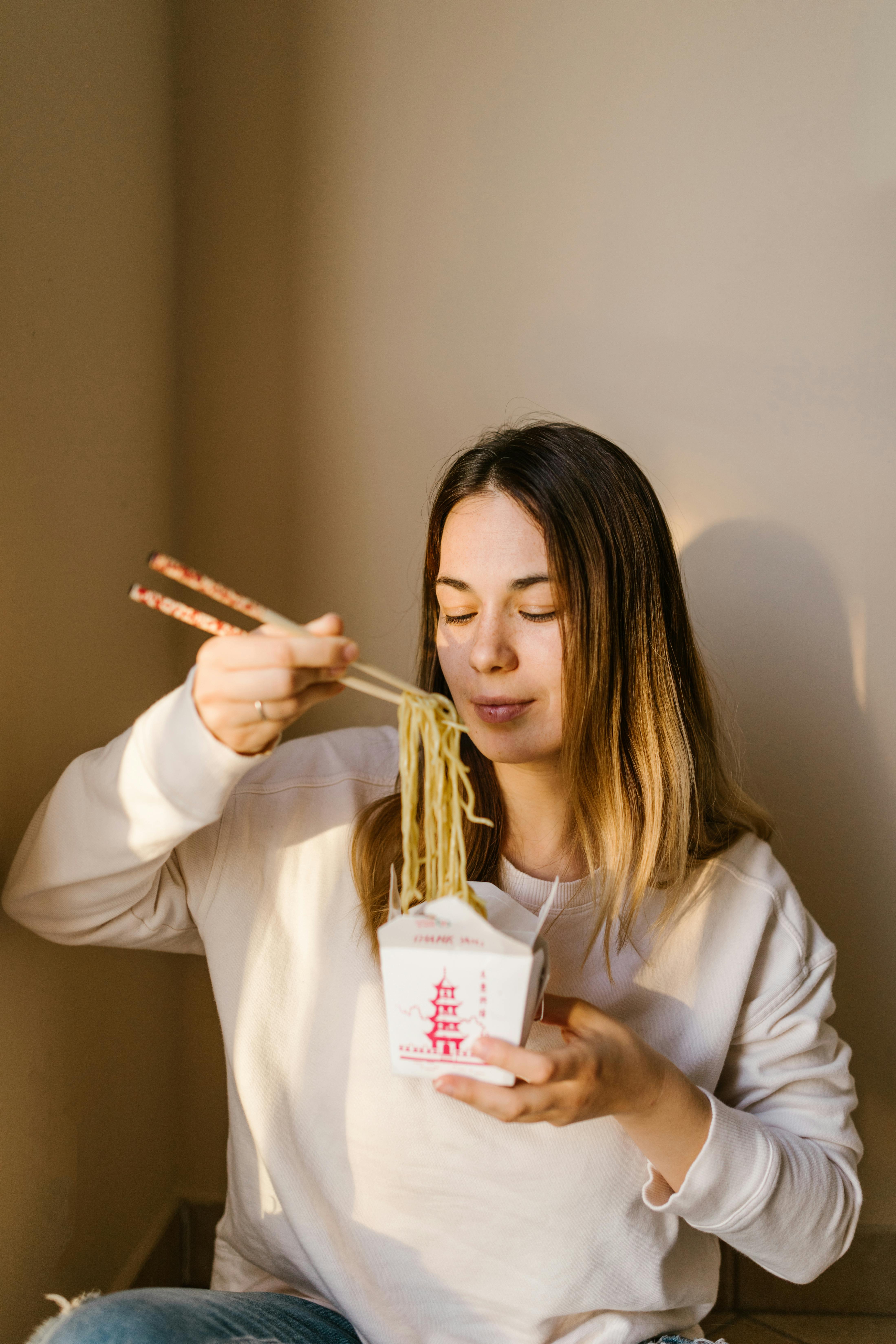 A Woman Eating Noodles · Free Stock Photo