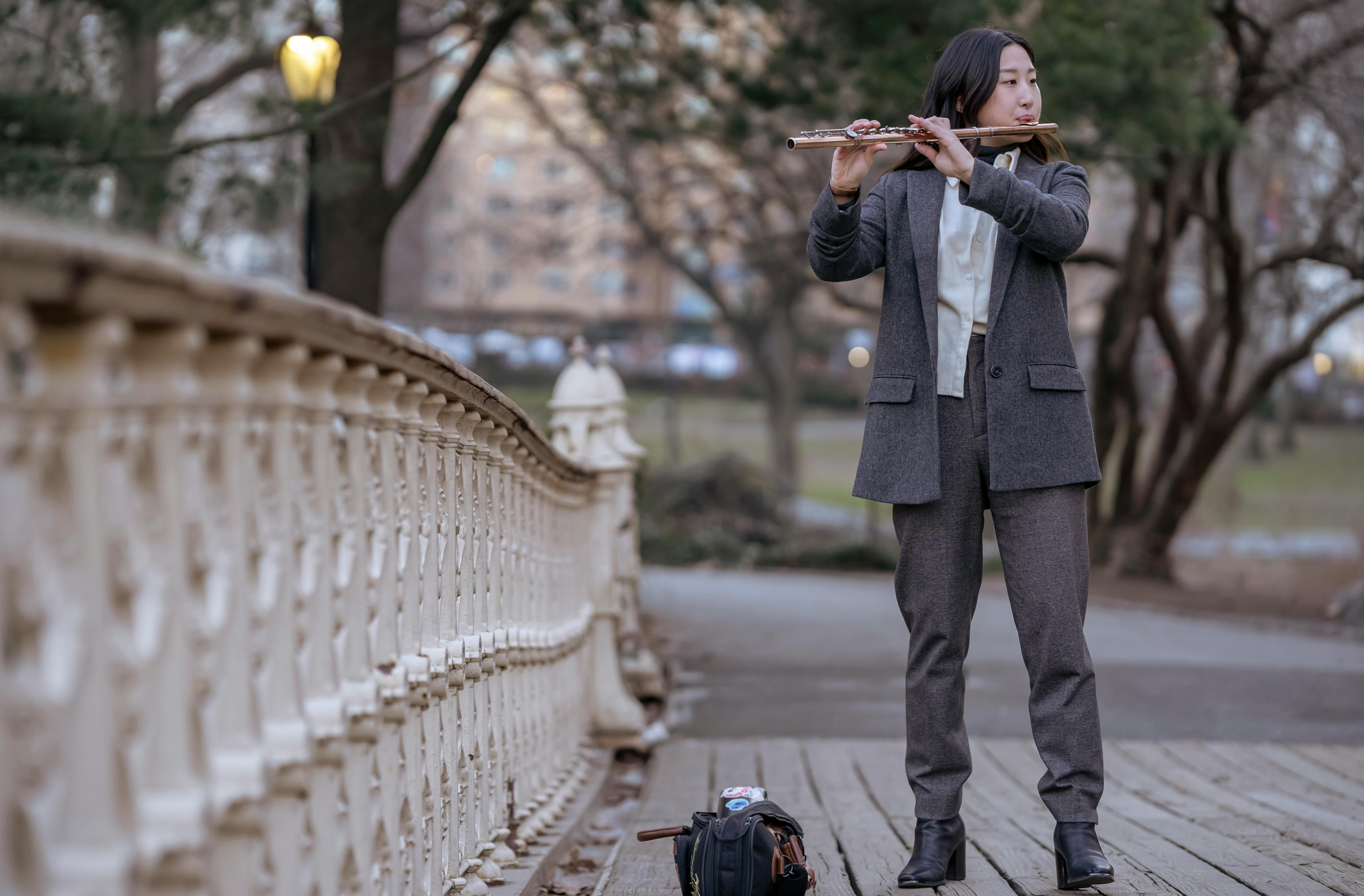 Woman Playing a Wind Instrument at a Park · Free Stock Photo